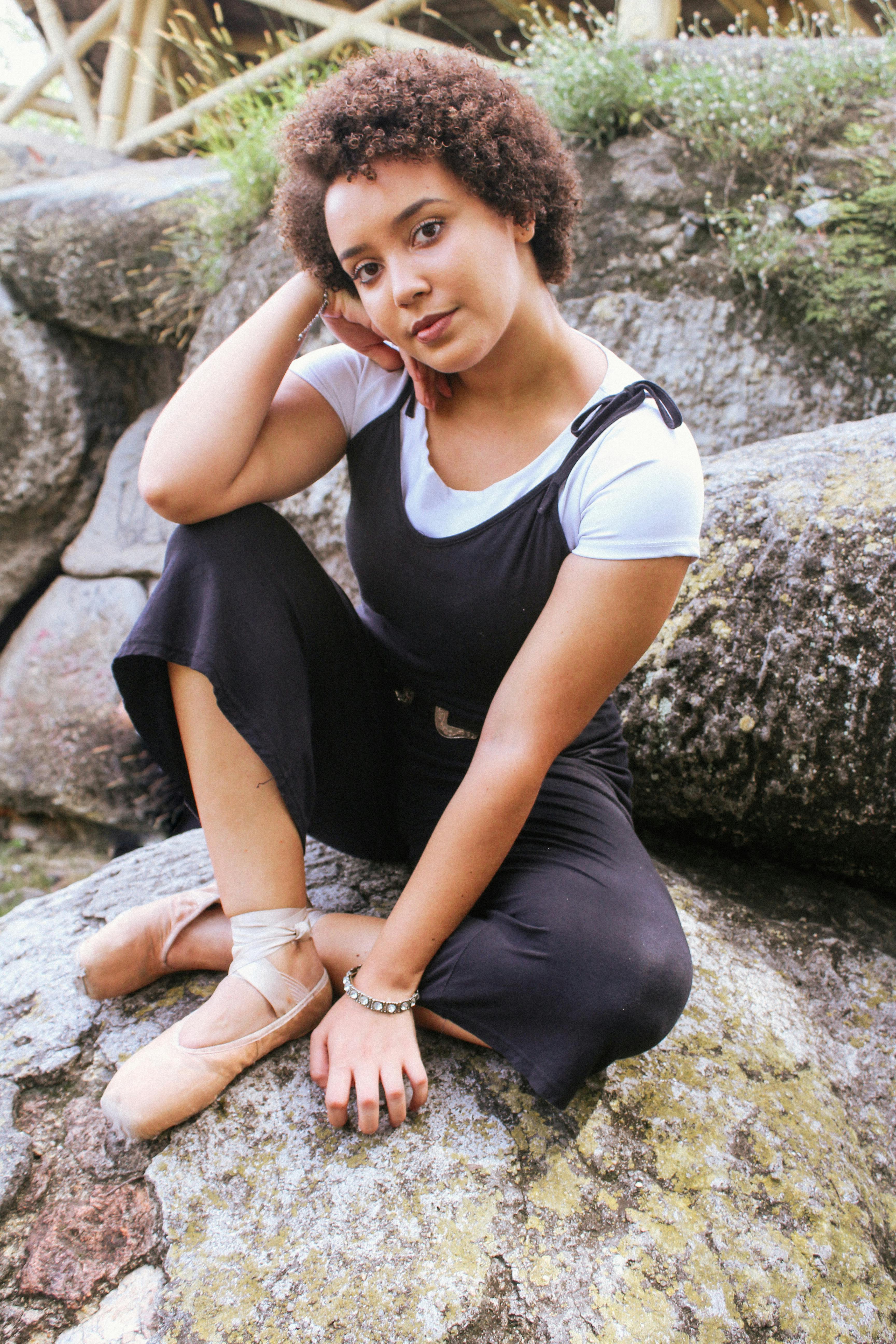 Woman Wearing Ballet Shoes Sitting on a Rock · Free Stock Photo