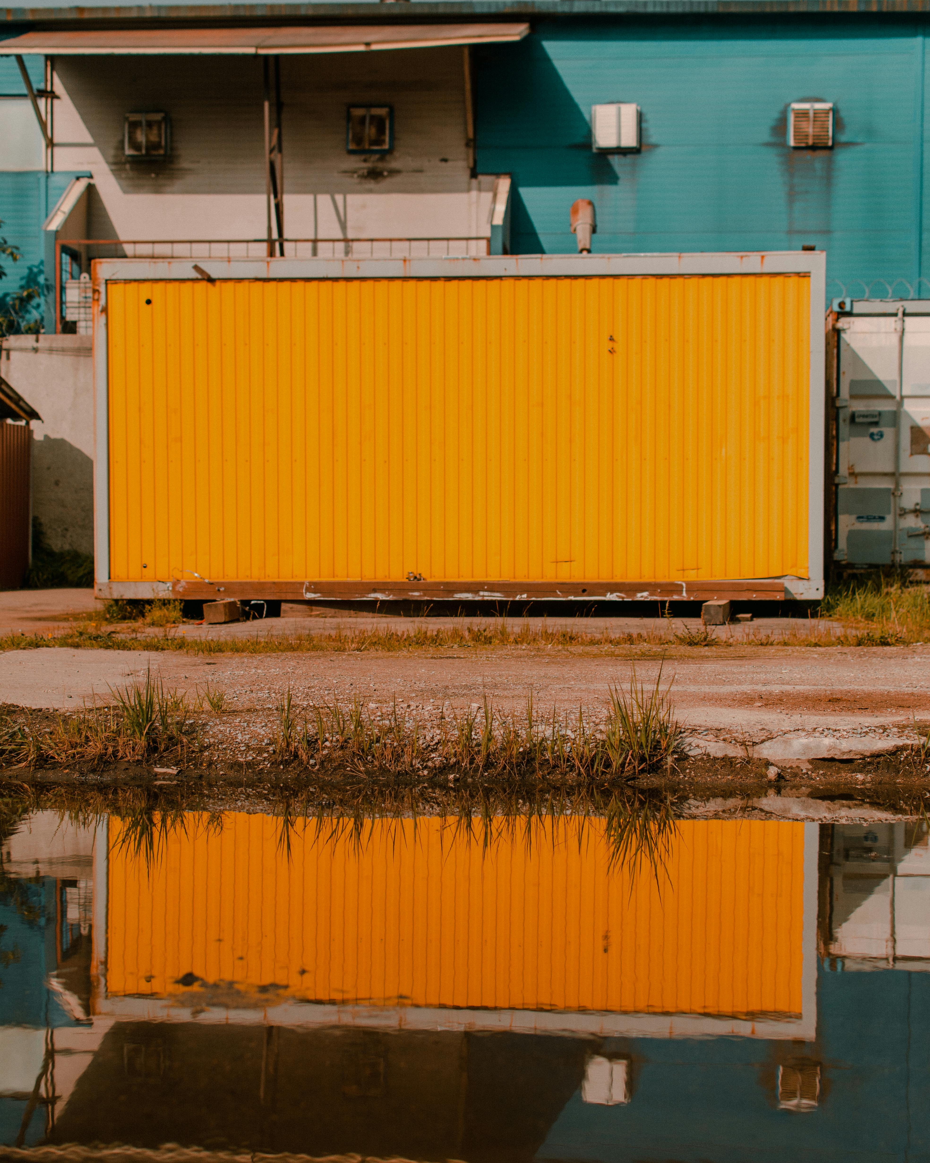 A Yellow Container Near a Flooded Road · Free Stock Photo