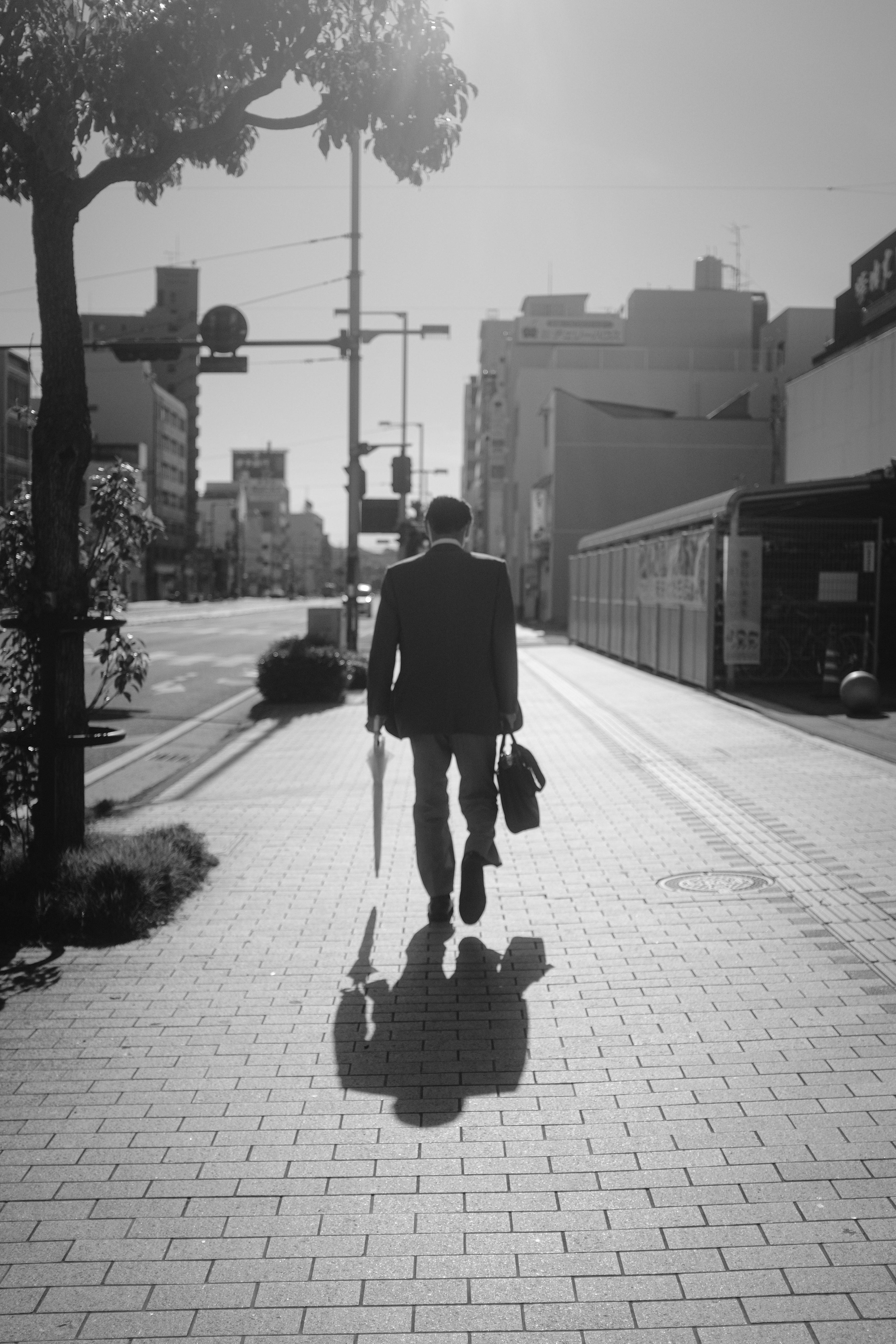 A Man Walking on Sidewalk · Free Stock Photo