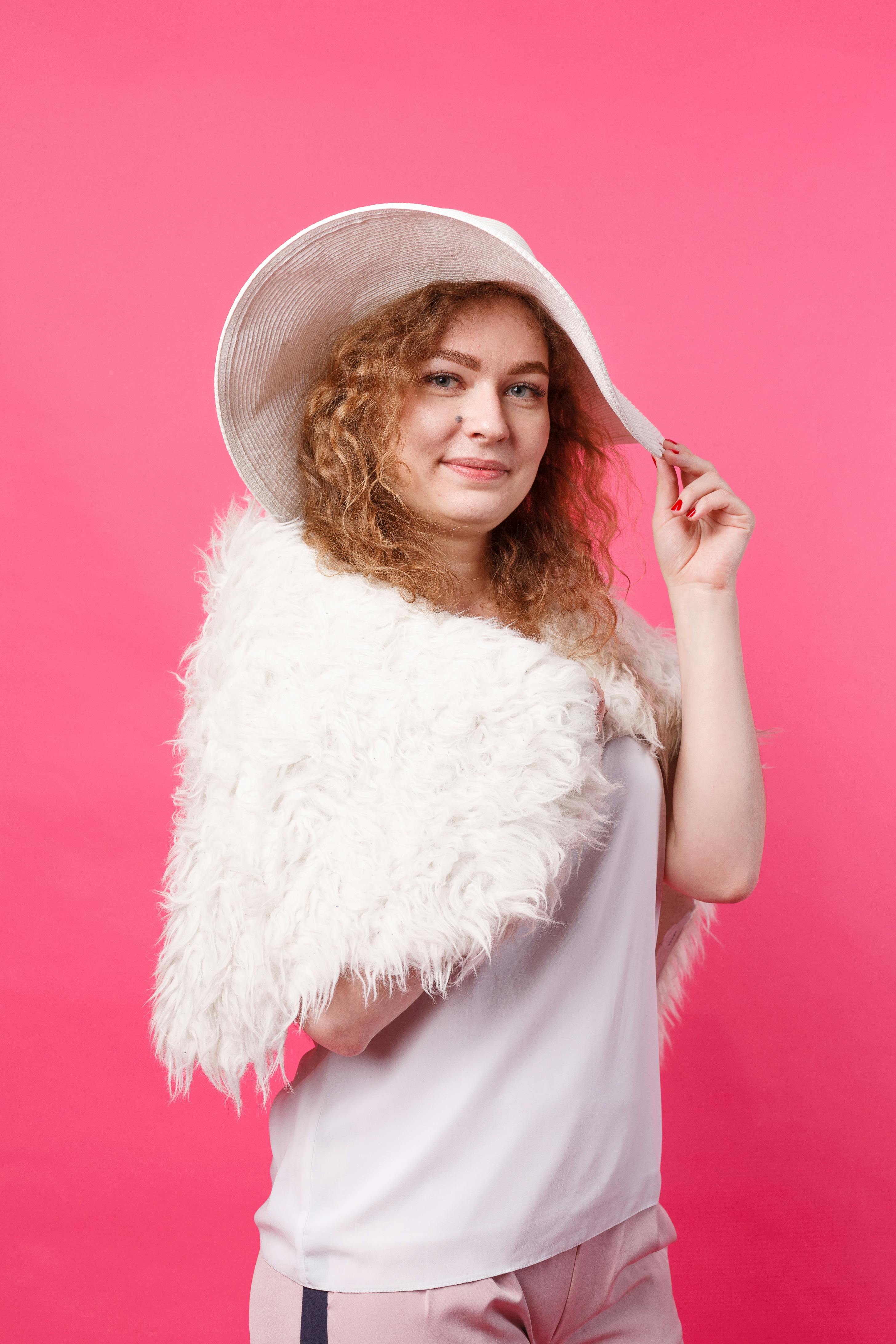 Woman in Pink Background Holding a Fur Cloth · Free Stock Photo