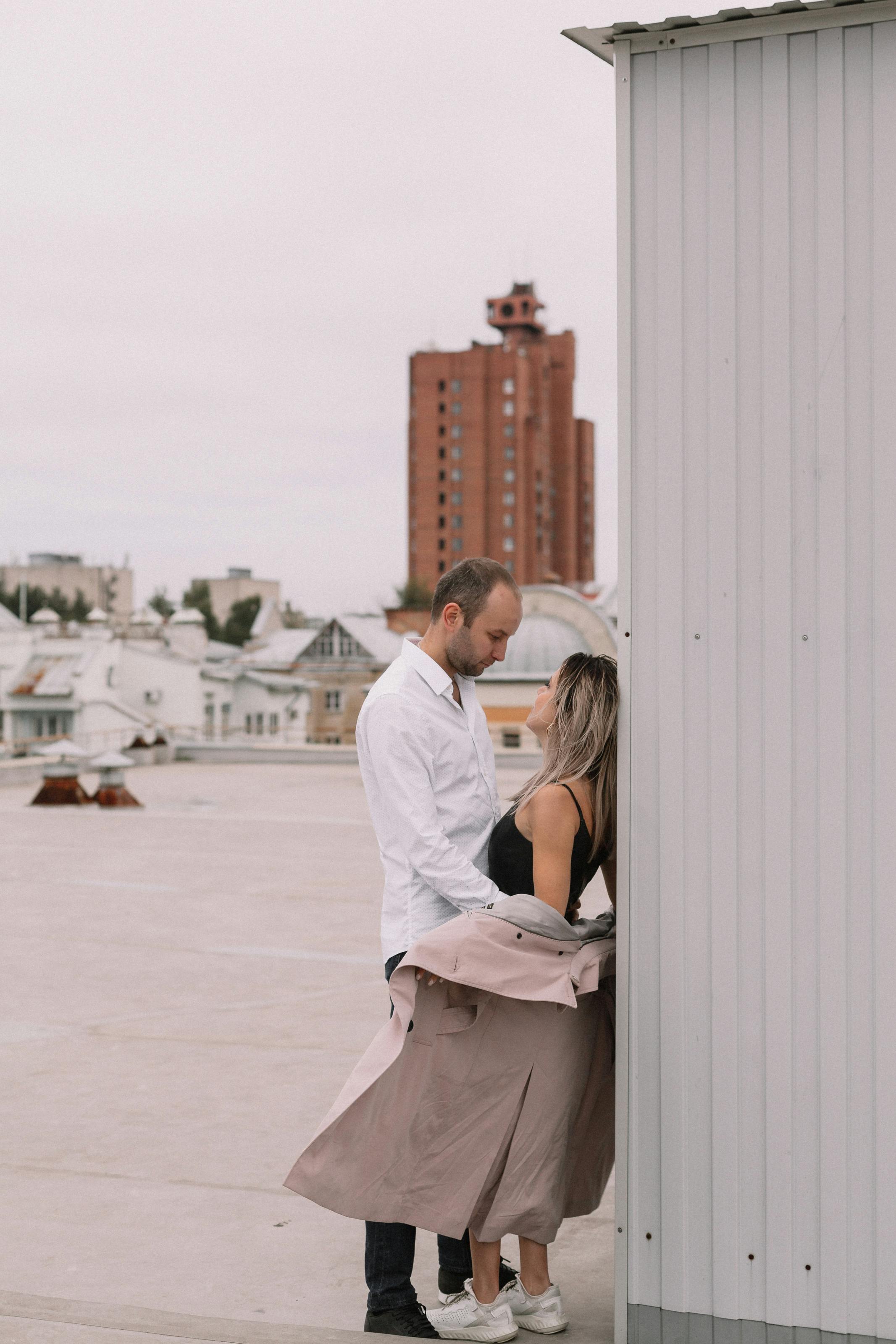 A Couple Hugging Behind a Building · Free Stock Photo