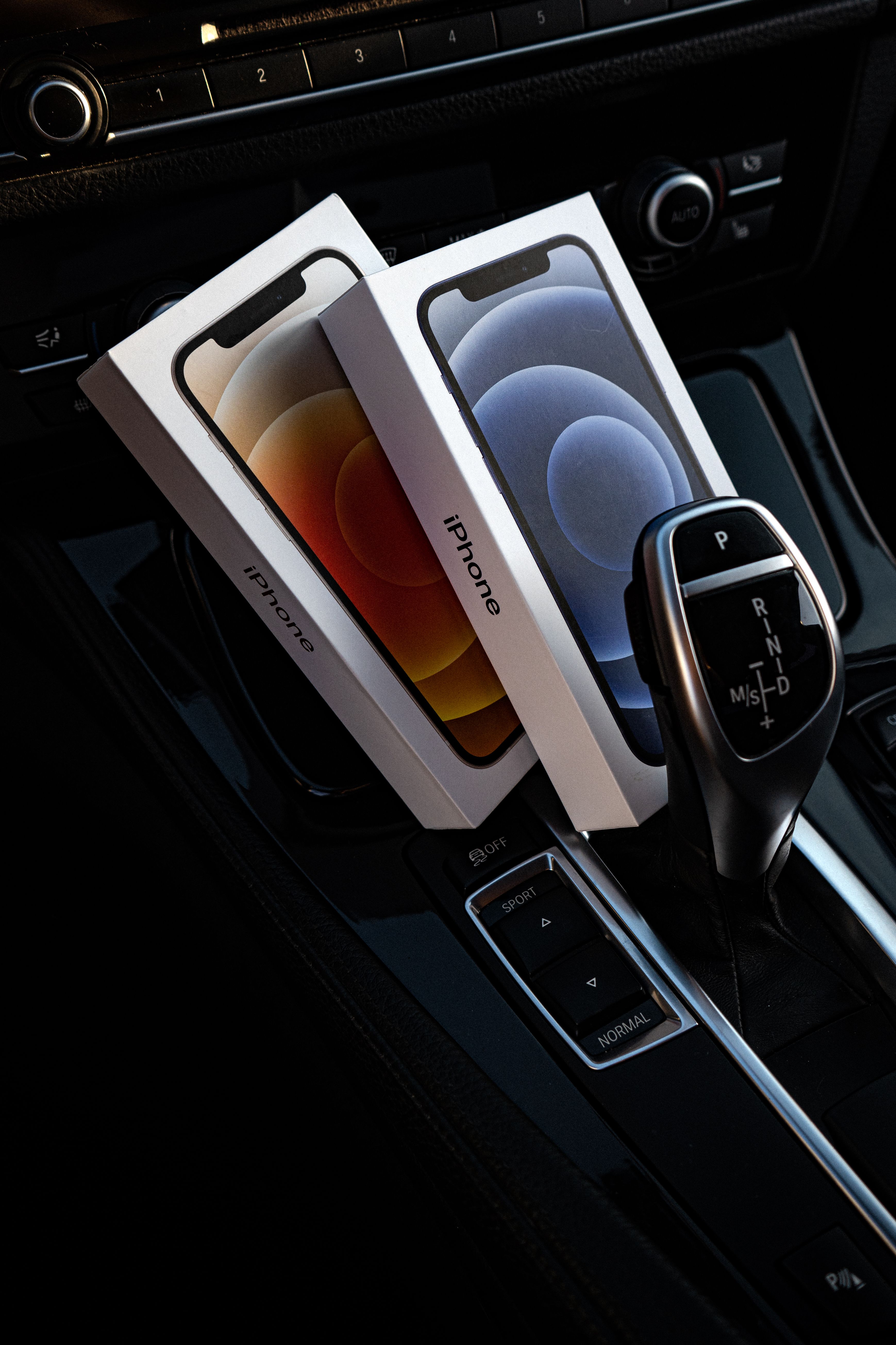 Black and White Cellphones in the Car · Free Stock Photo