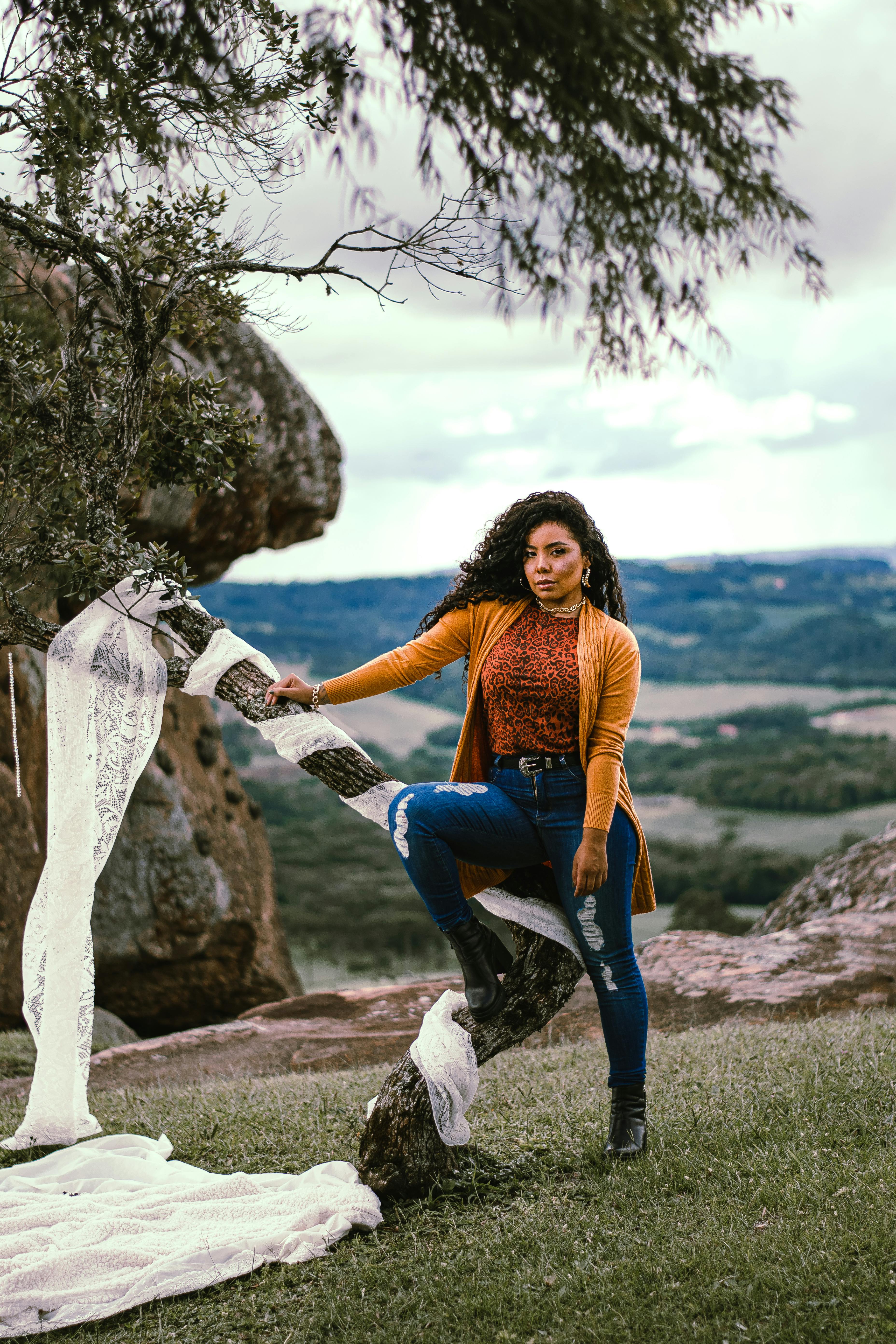 Woman Sitting on a Tree Trunk · Free Stock Photo