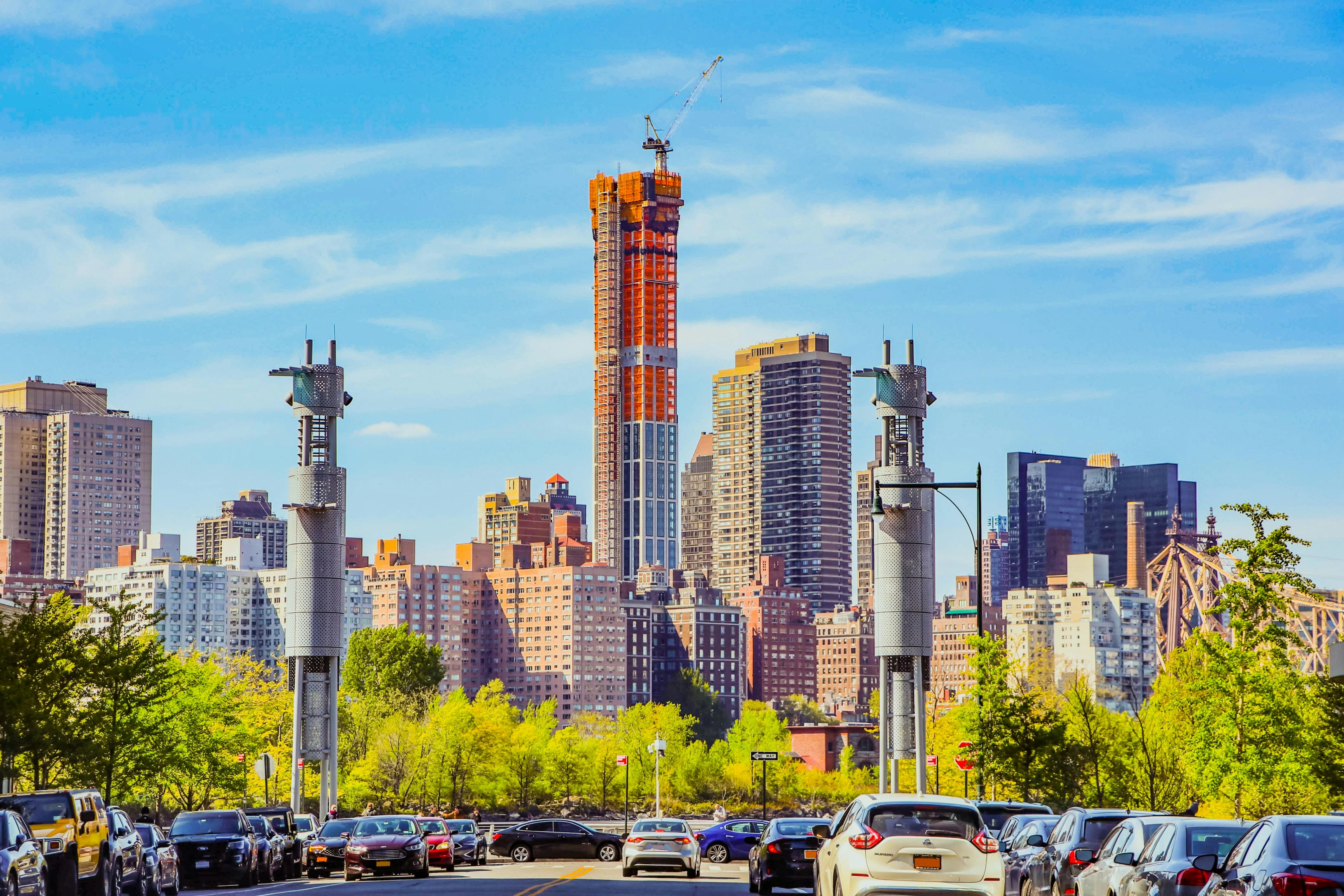 Cars Parked on Parking Lot Near High-rise Buildings · Free Stock Photo