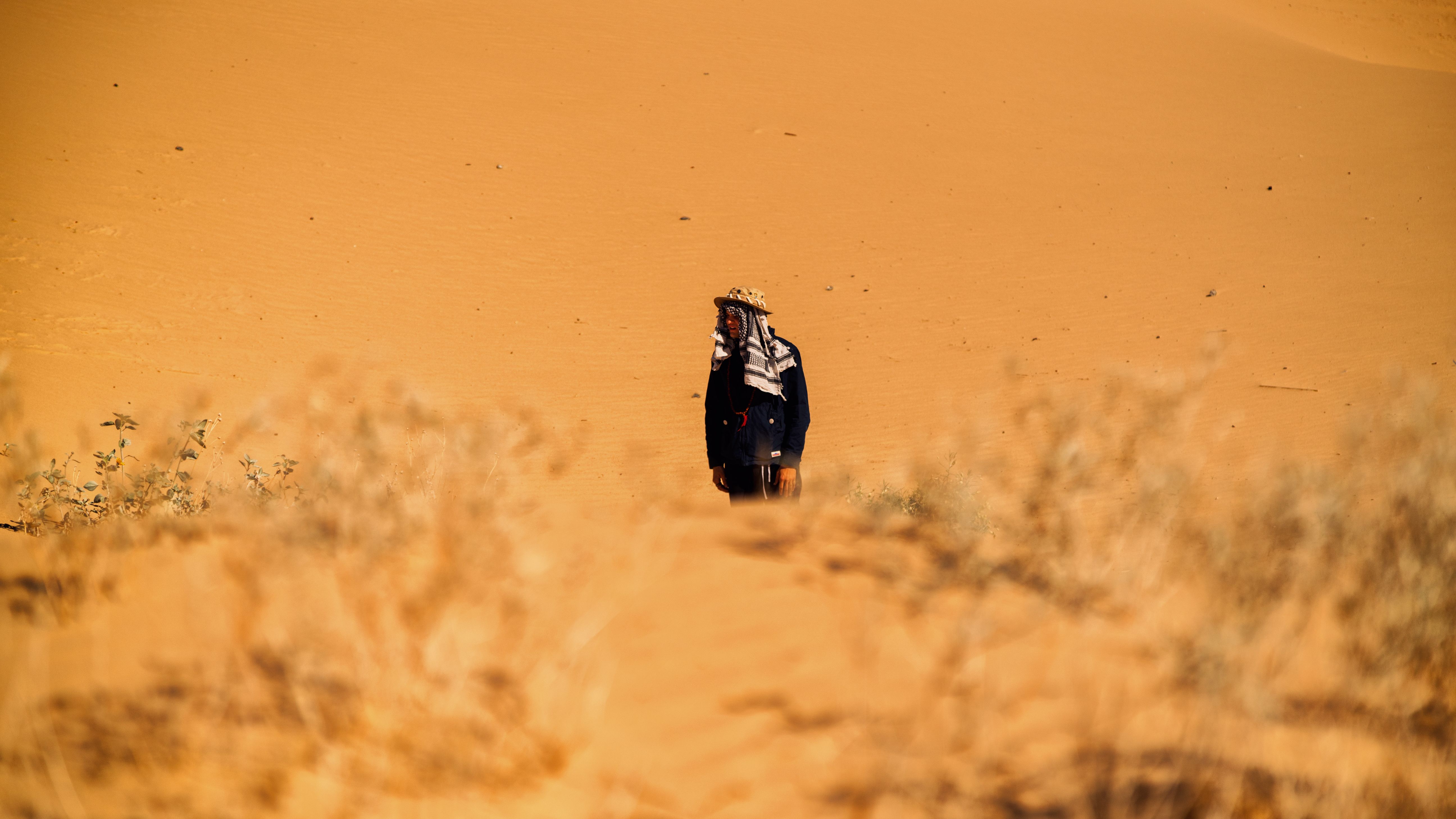 Man Standing With Raised Arms in the Middle of a Desert · Free Stock Photo