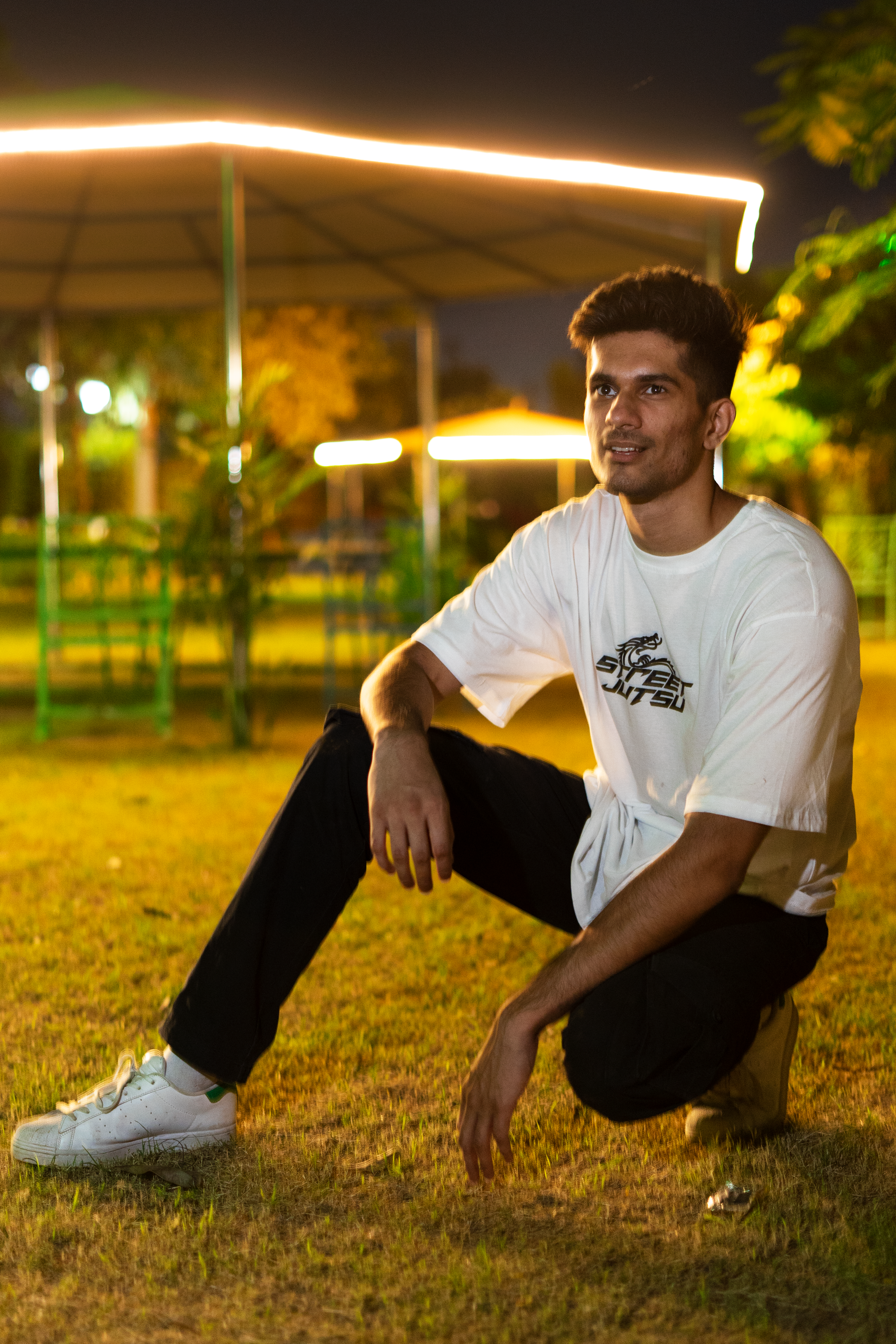 Man in White Crew Neck Shirt sitting on Grass · Free Stock Photo