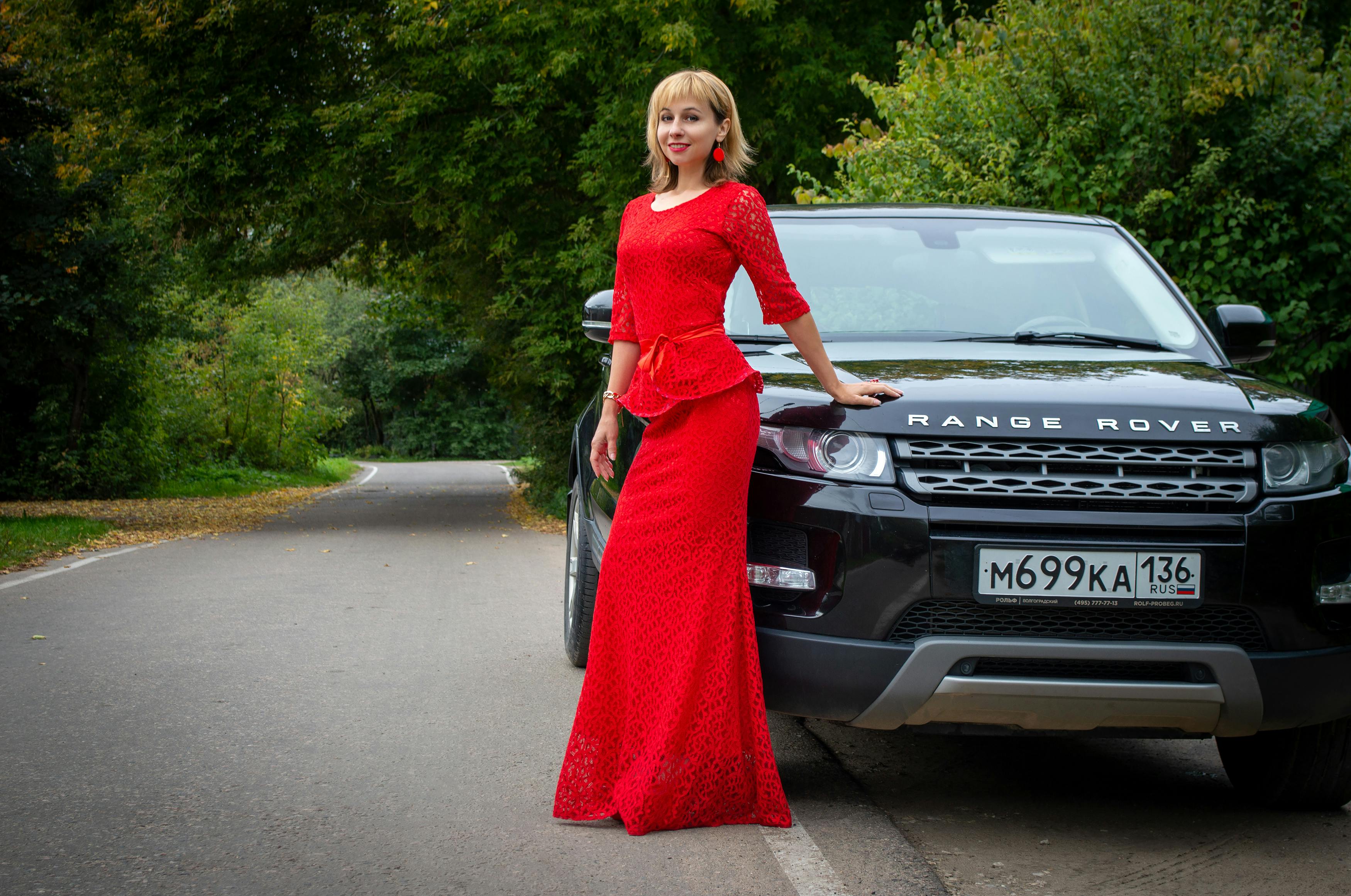 Beautiful Woman in Red Dress Standing Beside Black Car · Free Stock Photo
