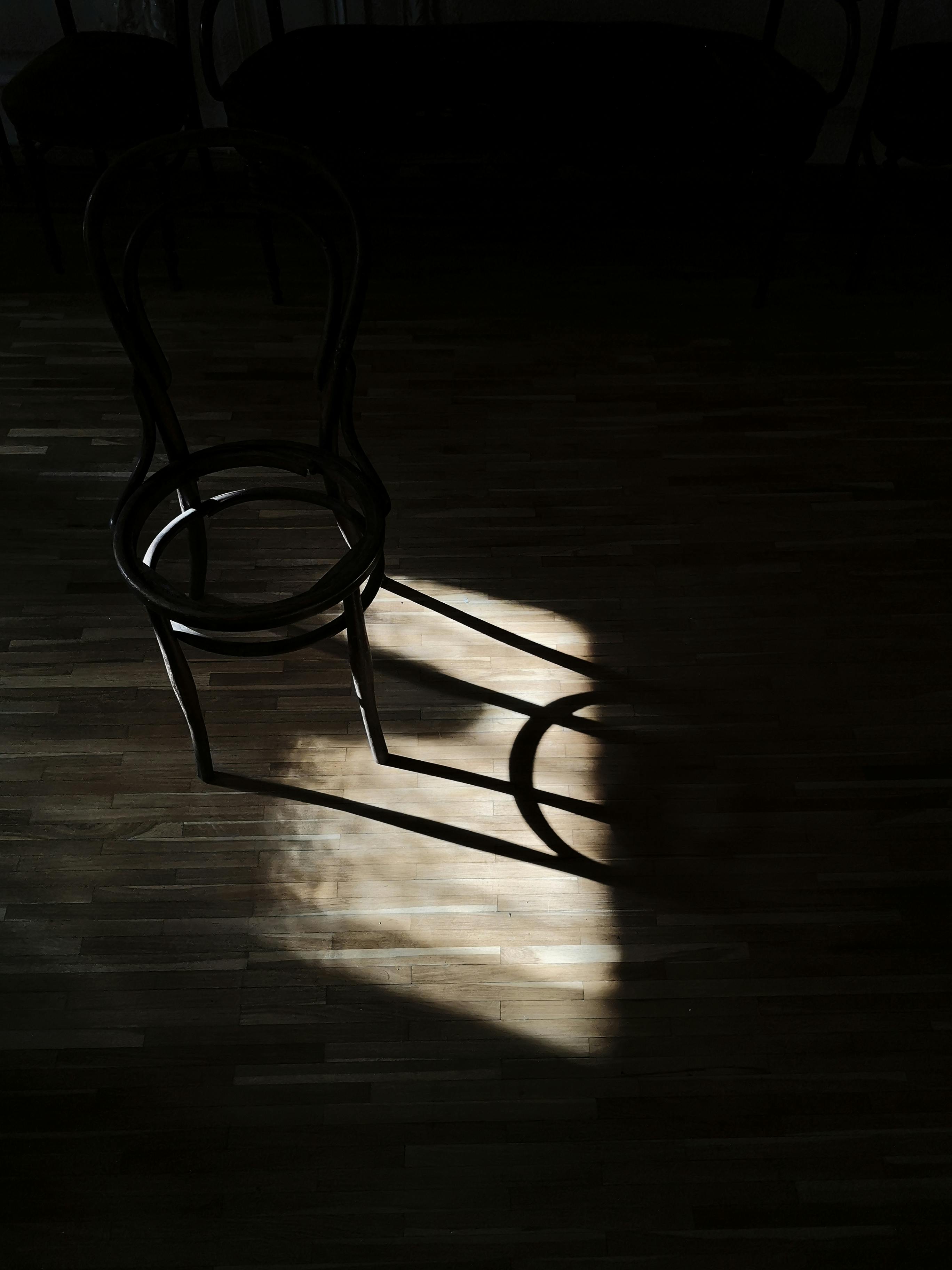 Empty Chair in Light in Room in Shadow · Free Stock Photo