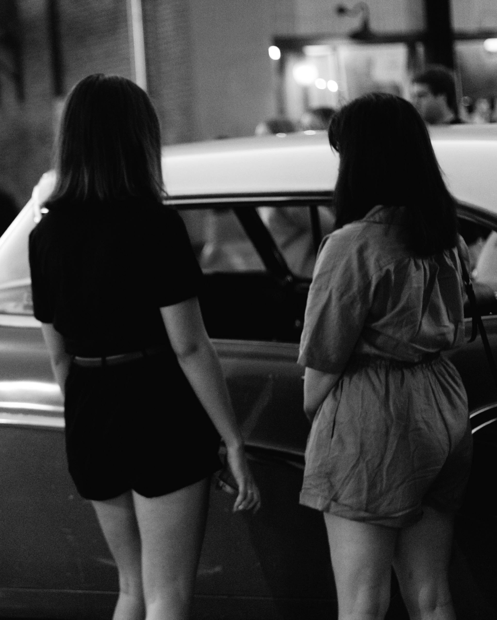 Two Girls Standing Back to Back · Free Stock Photo