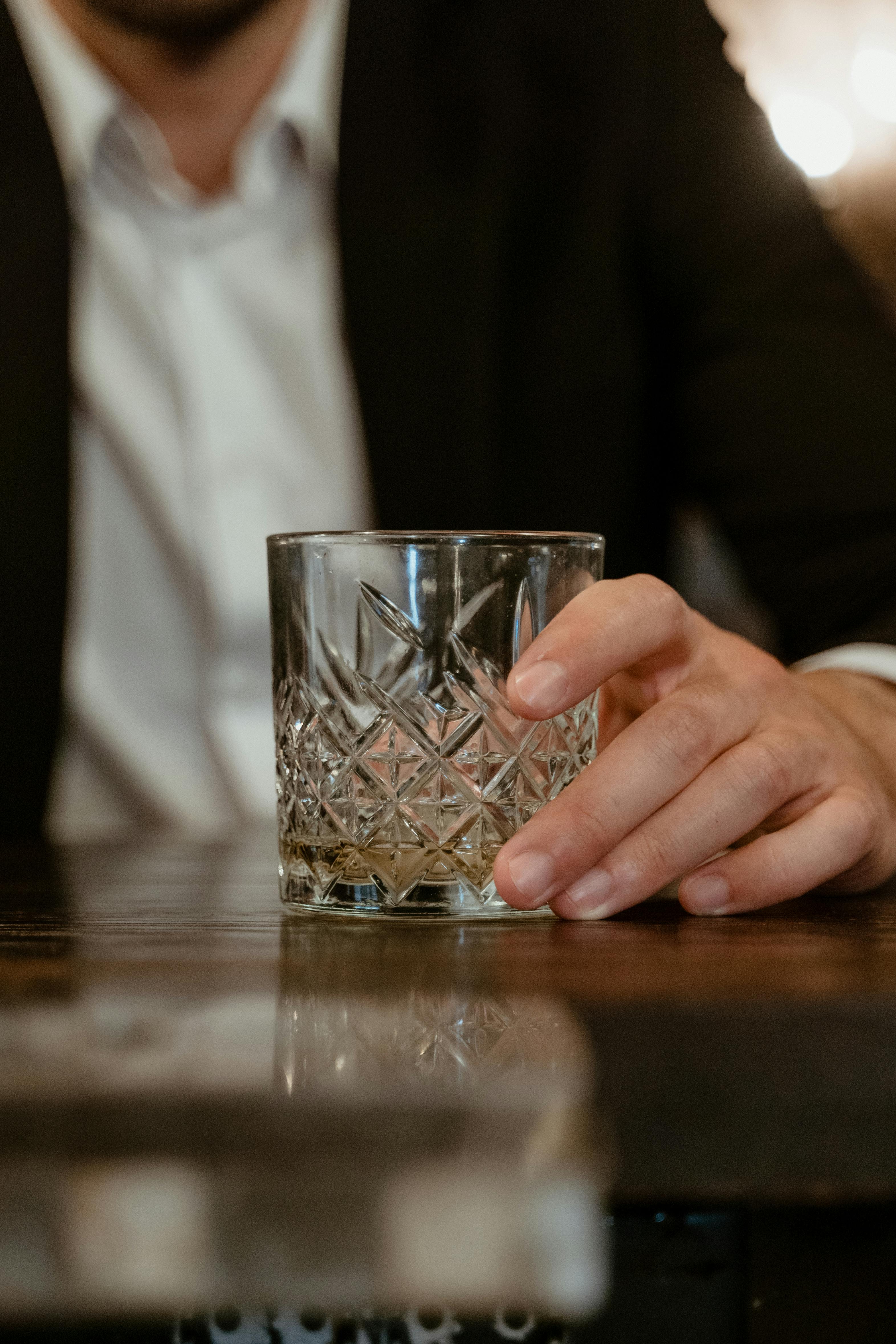 Man in Suit Holding Clear Drinking Glass · Free Stock Photo