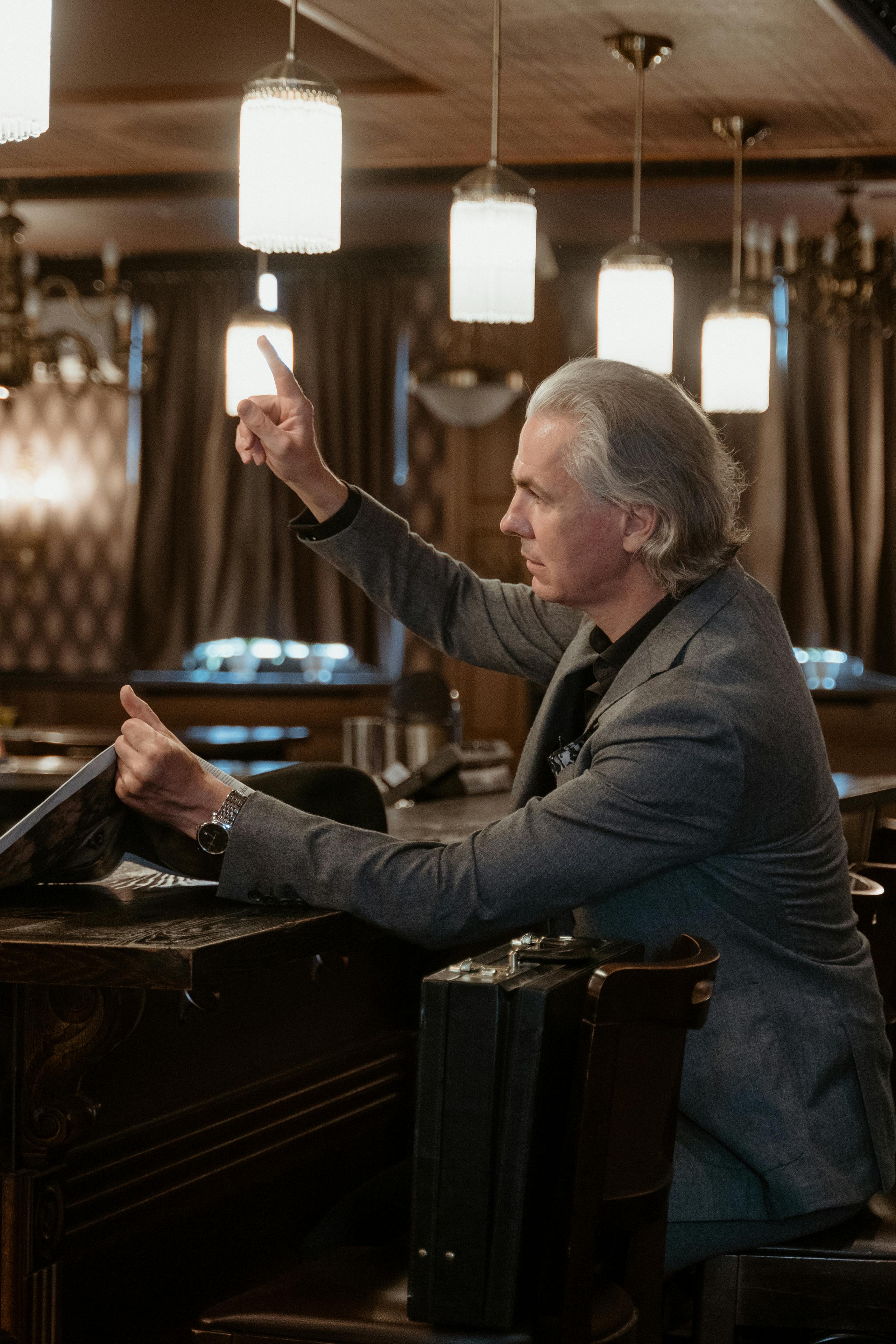 Man Sitting at the Bar Counter · Free Stock Photo