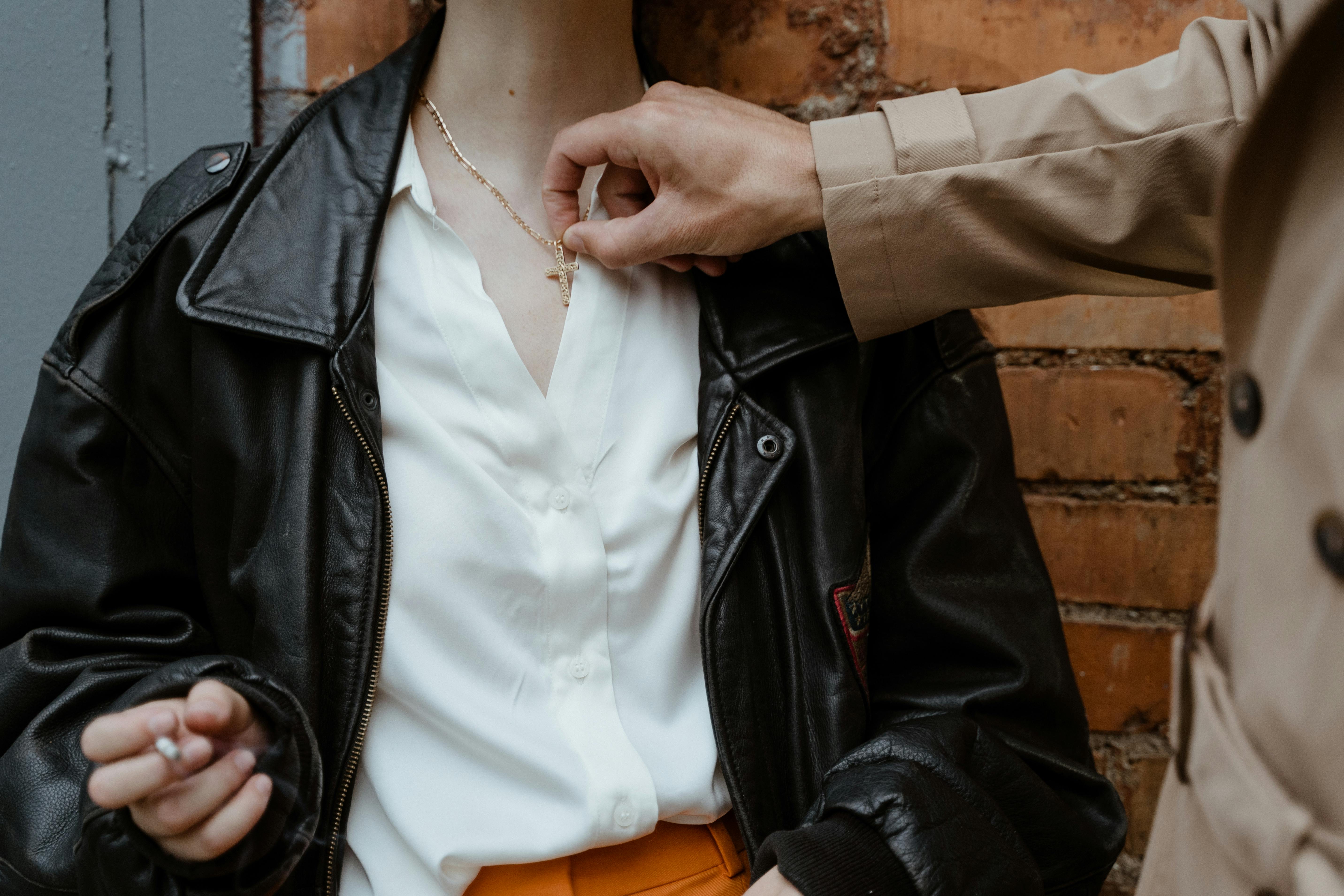 Photo of a Person Touching Another Person's Necklace · Free Stock Photo
