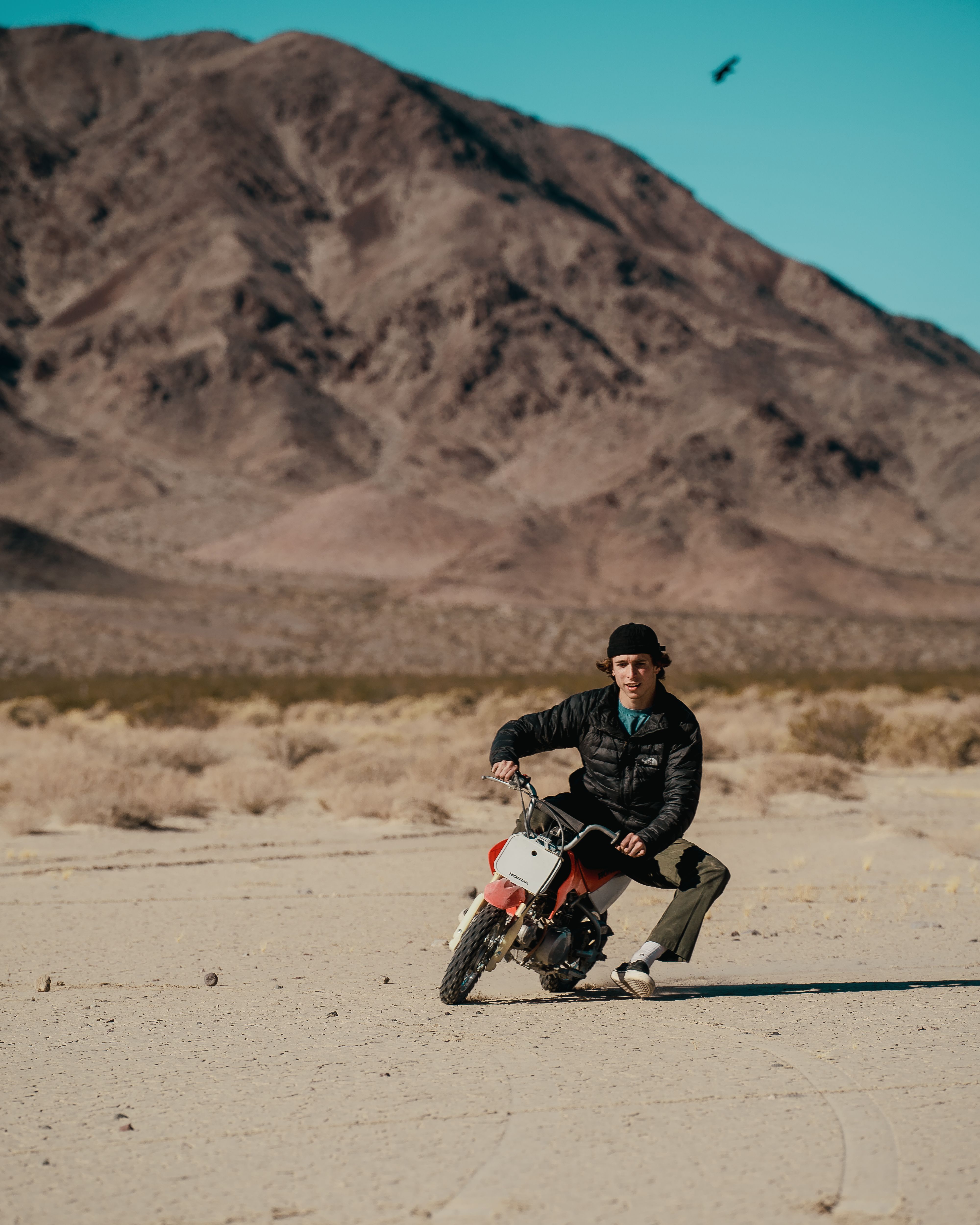 A Man Riding a Small Motorcycle on Dirt Road · Free Stock Photo