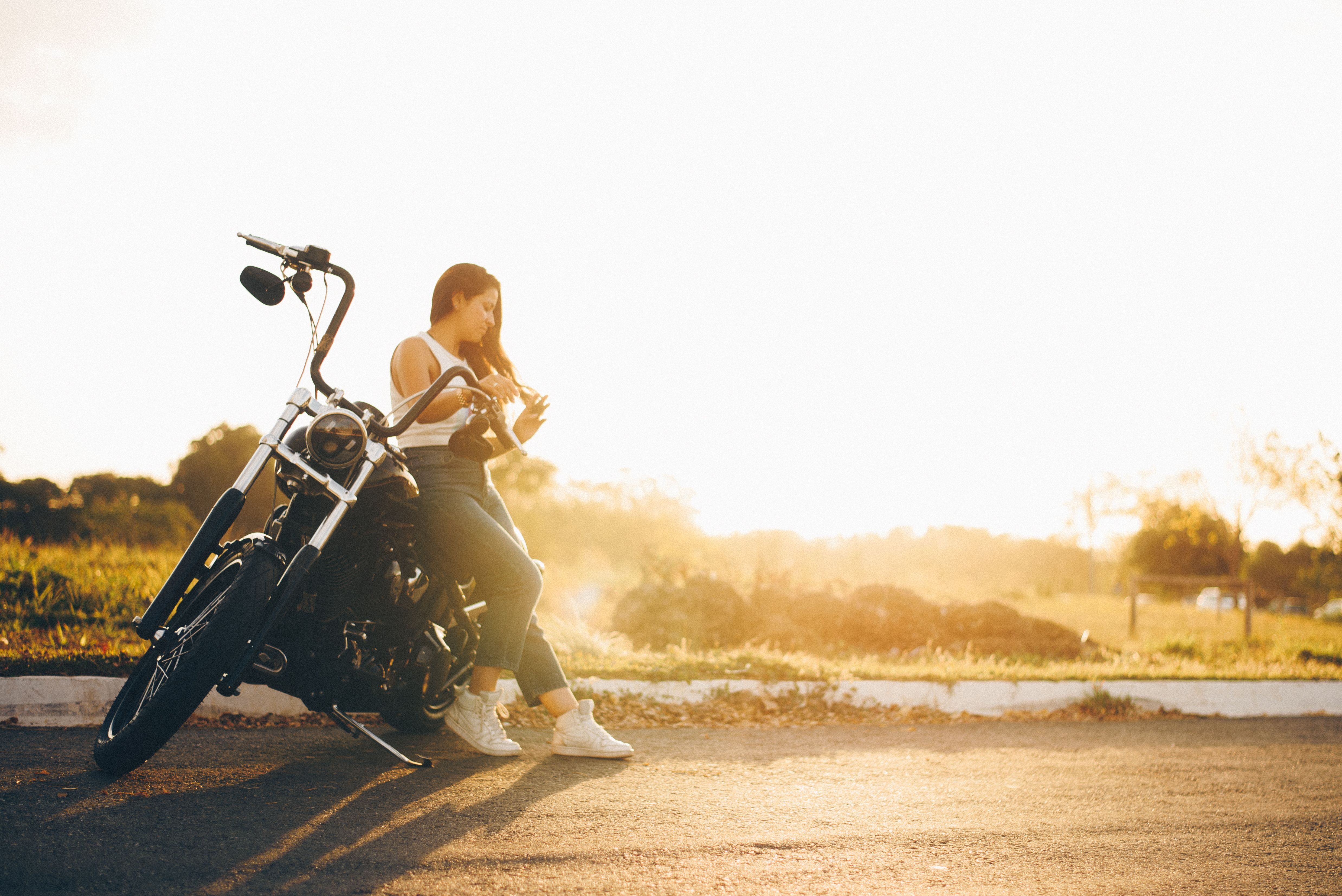 Stylish Woman leaning on a Motorcycle · Free Stock Photo