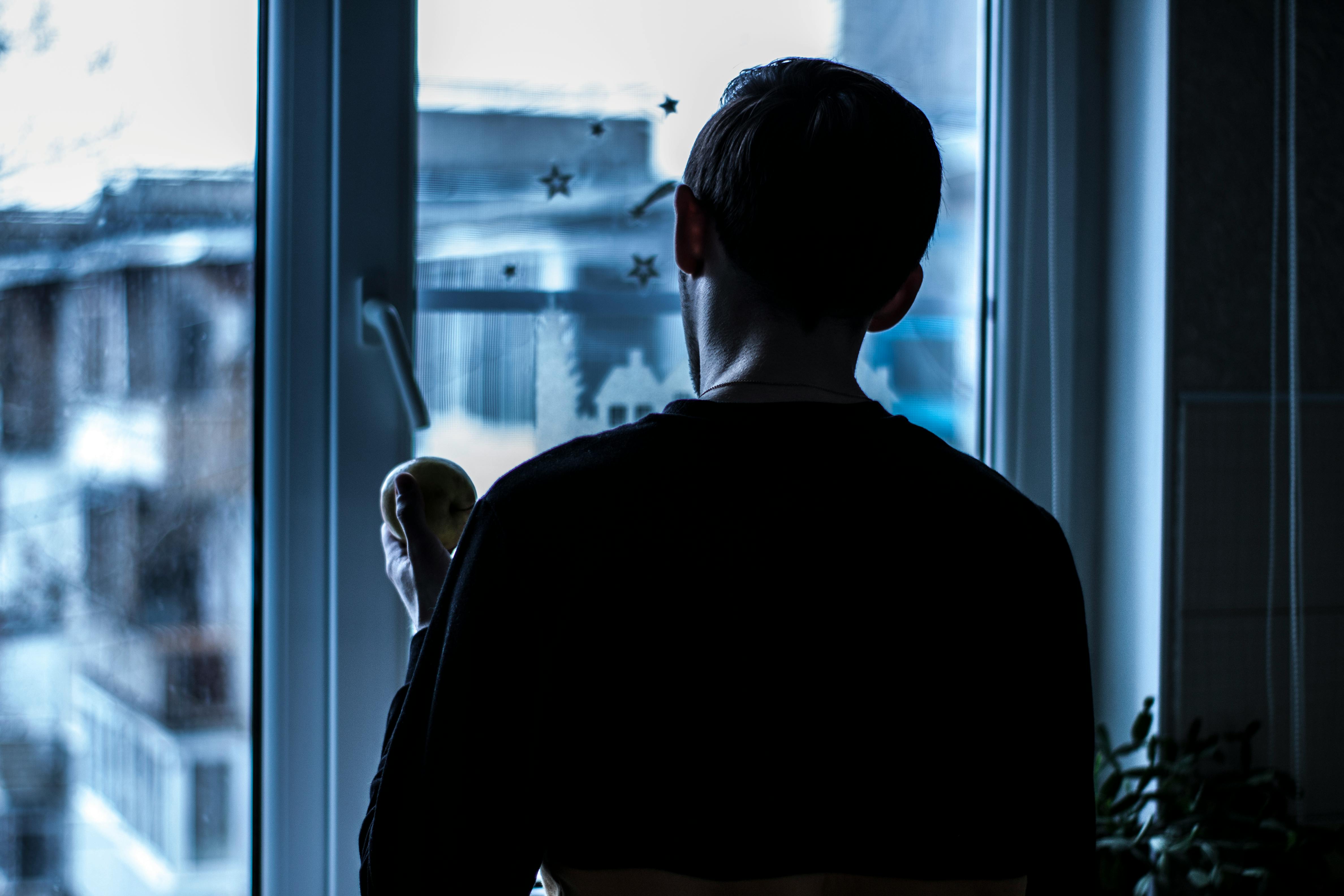 Man Looking Outside Near Clear Glass Window · Free Stock Photo