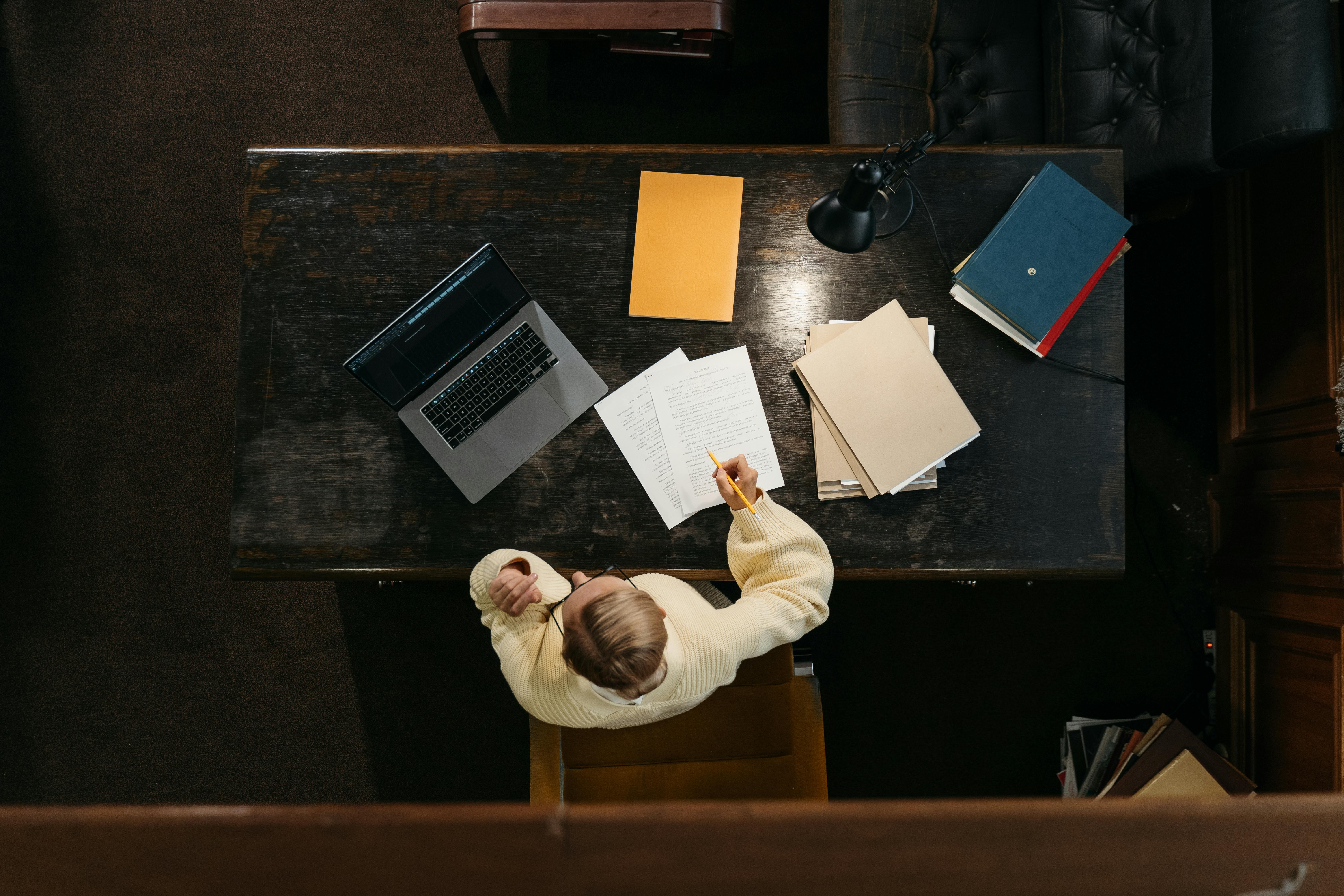 Top View of a Person Sitting Behind a Desk · Free Stock Photo