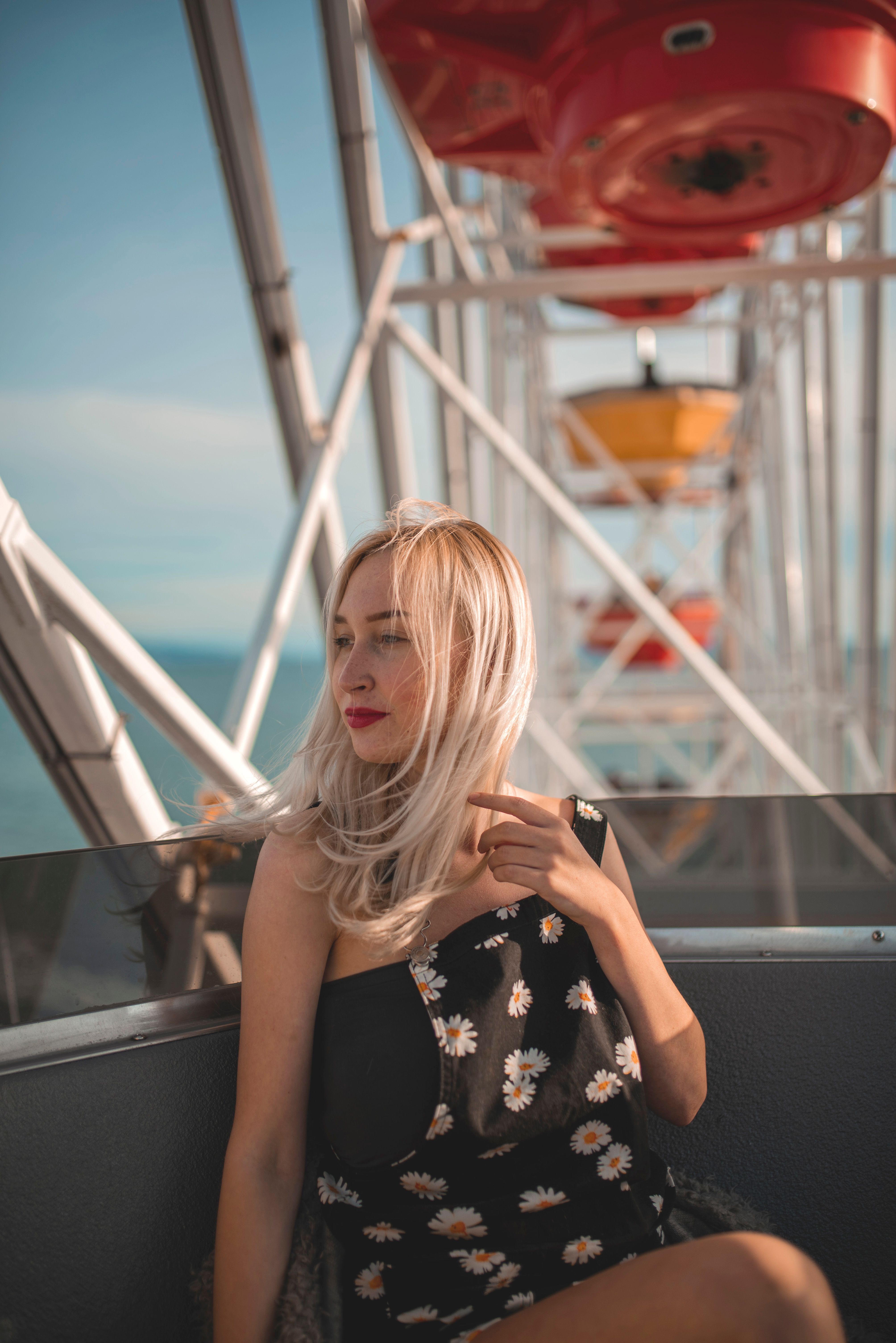 Woman Sitting on a Ferris Wheel · Free Stock Photo