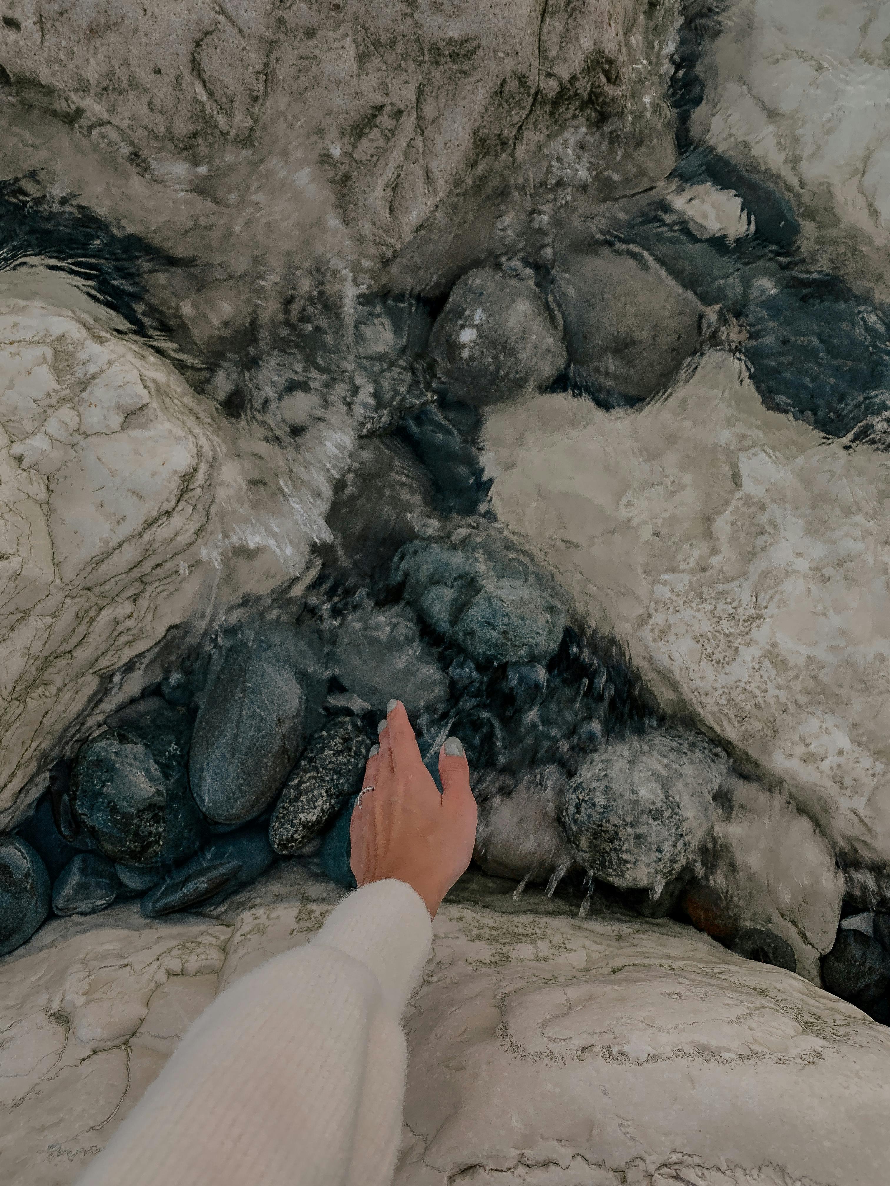 Woman Hand Touching Water Surface · Free Stock Photo