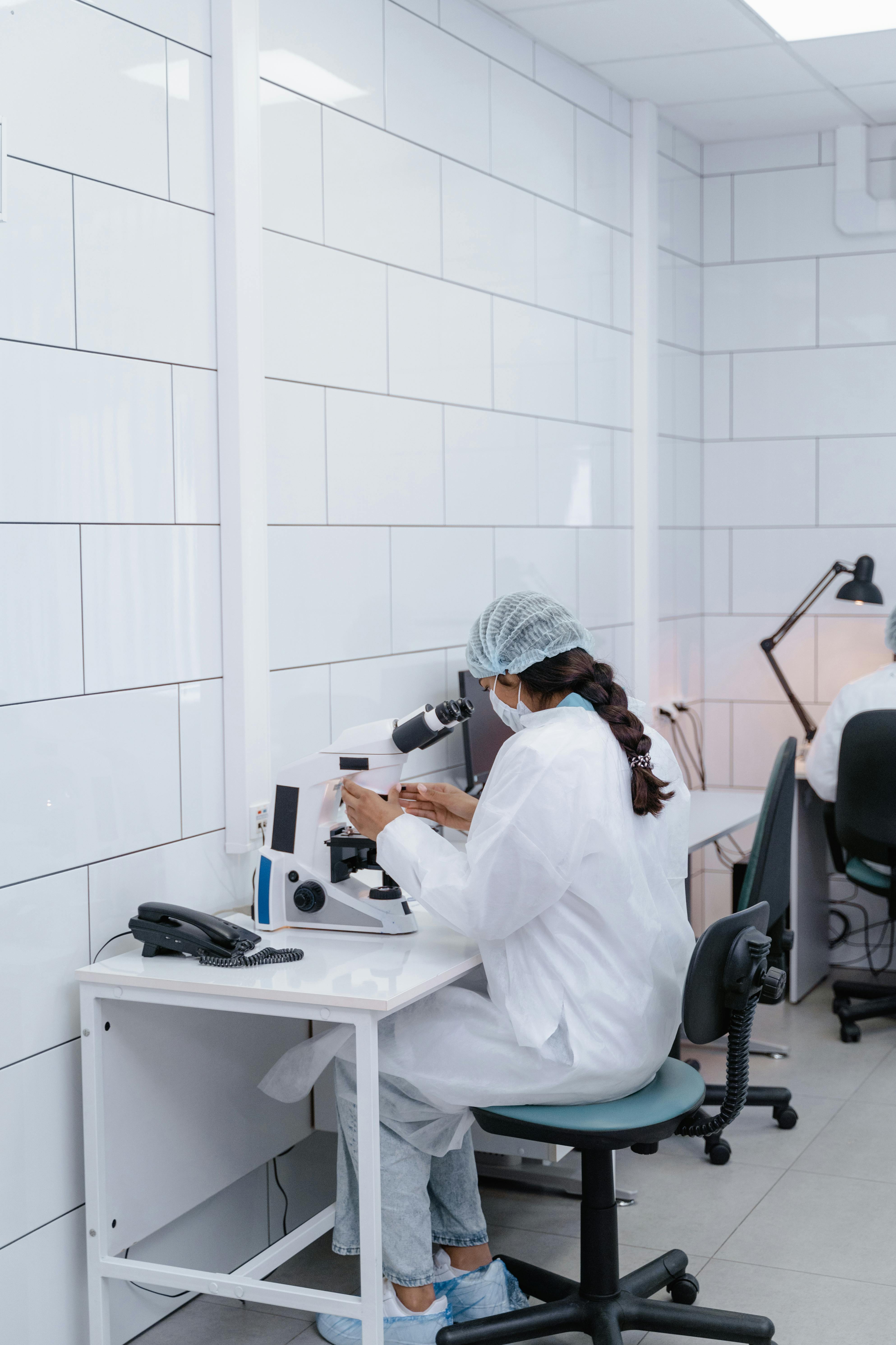 Medical Professional using Microscope · Free Stock Photo