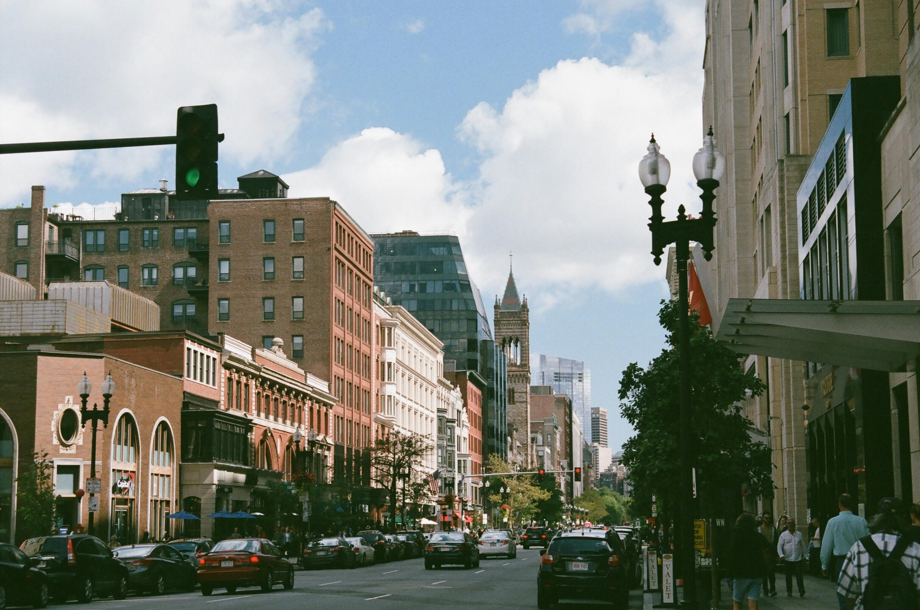 Vehicles In The Middle Of The Street Surrounded With Buildings · Free ...