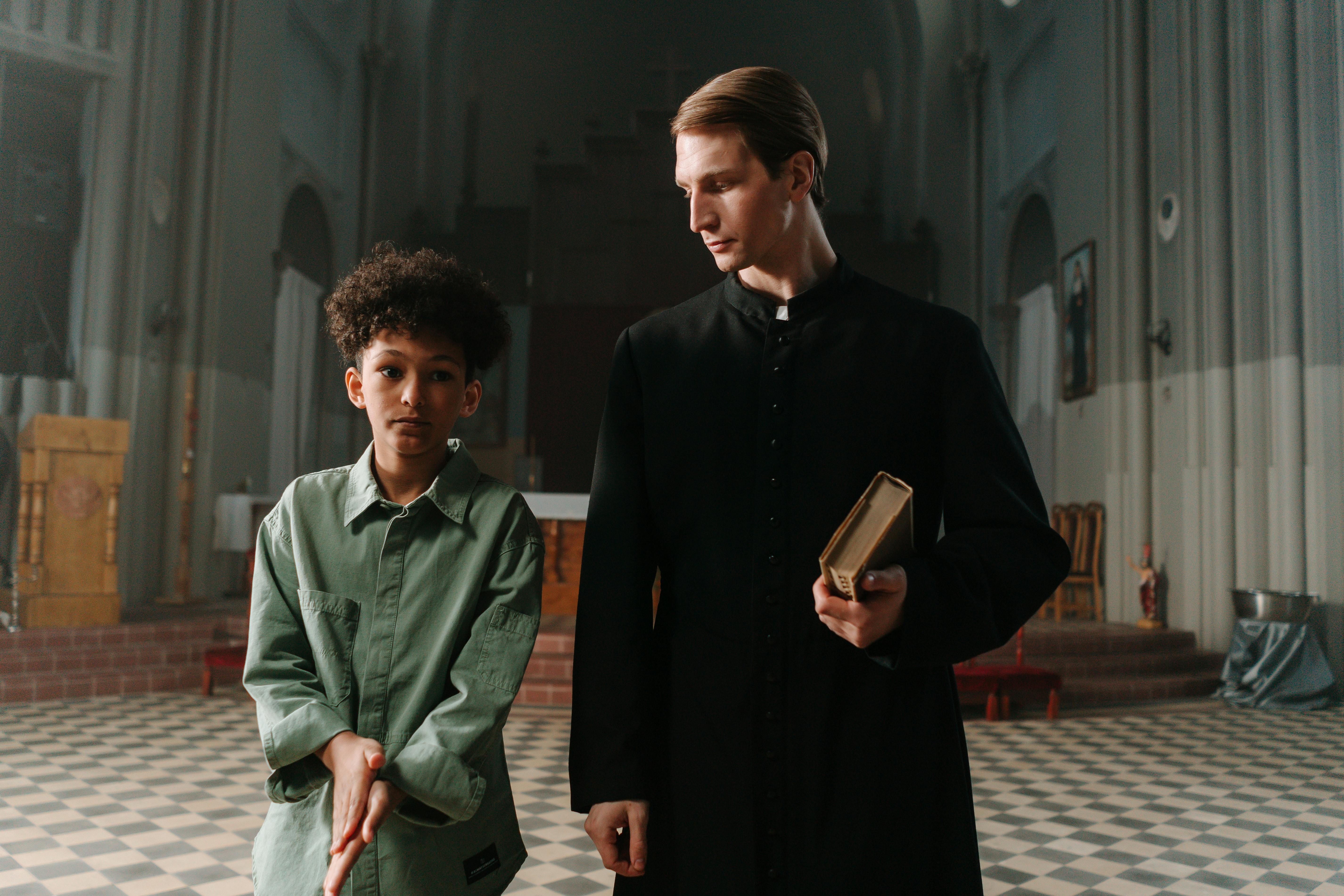 A Boy Standing Beside the Priest · Free Stock Photo