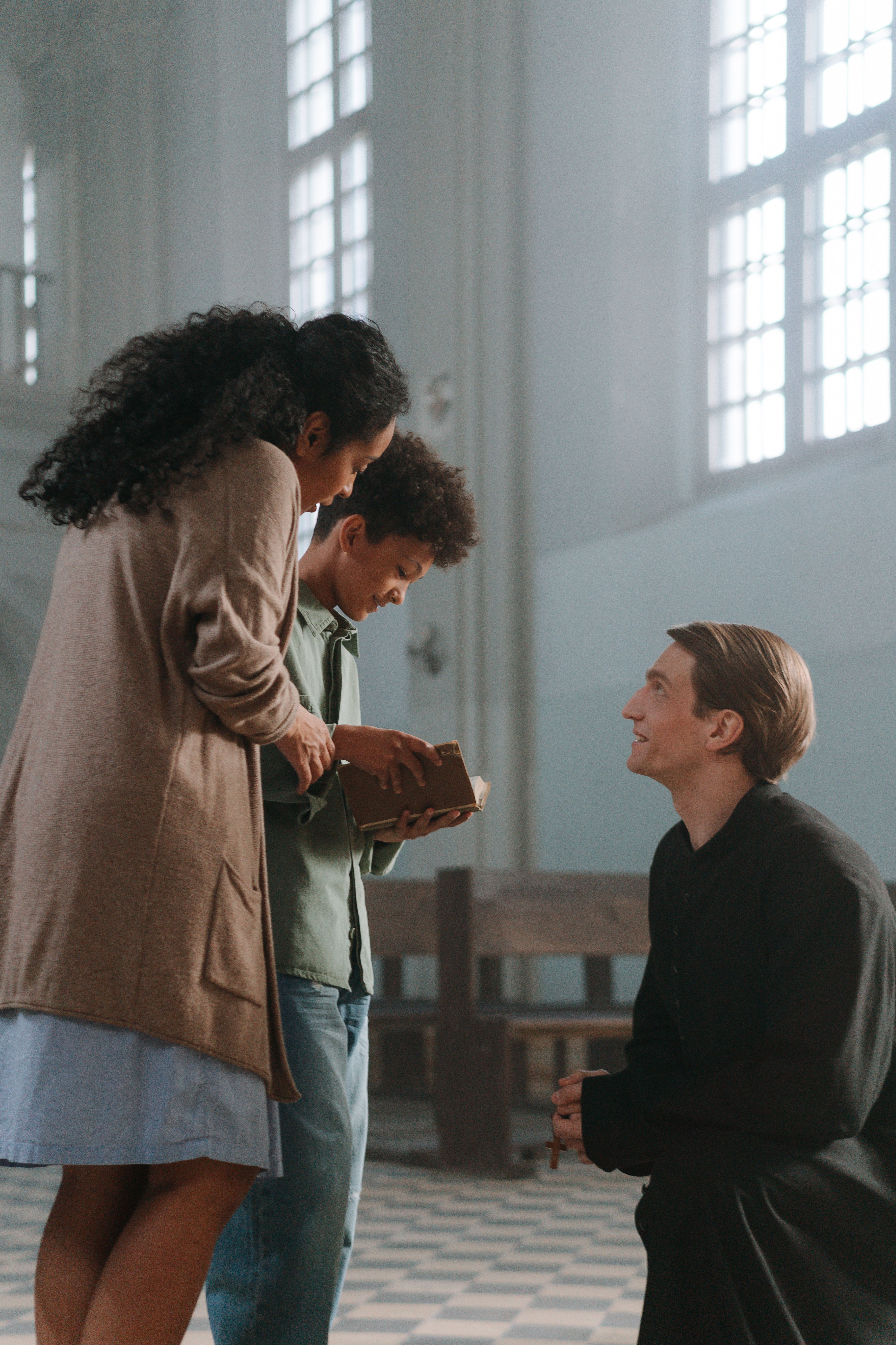 A Boy Holding a Bible · Free Stock Photo