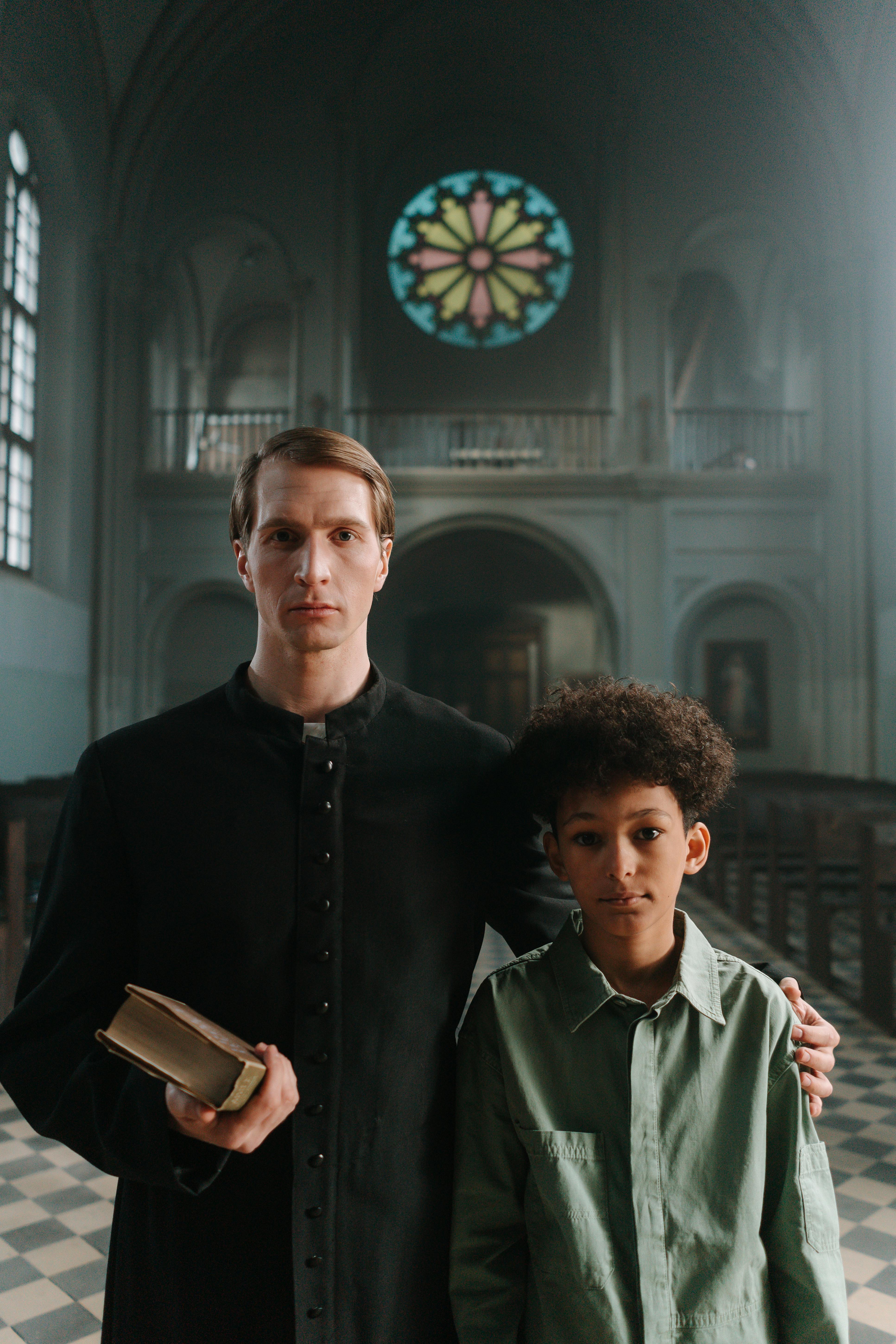 A Boy Standing Beside the Priest · Free Stock Photo