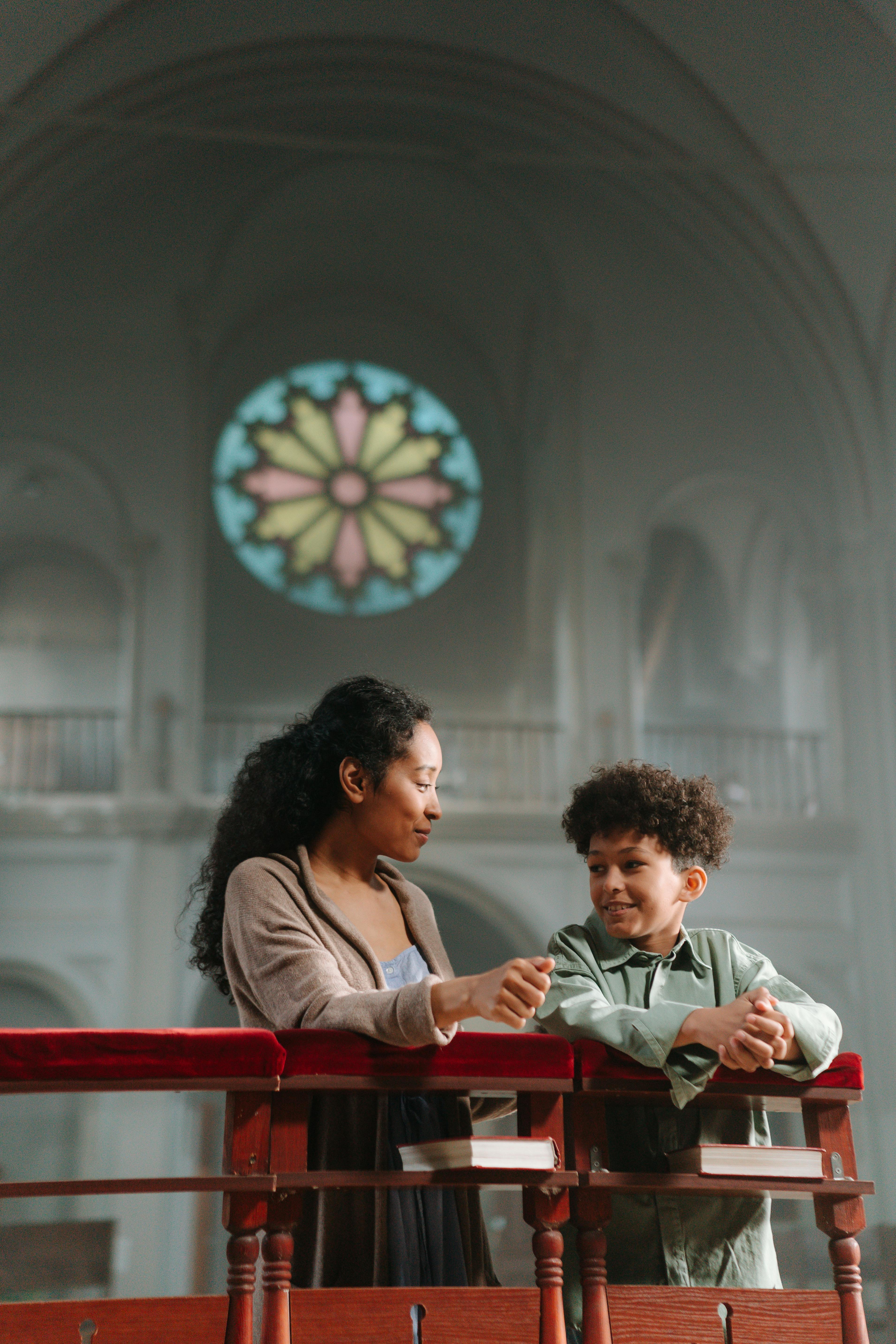 Mother and Child Kneeling in the Church · Free Stock Photo