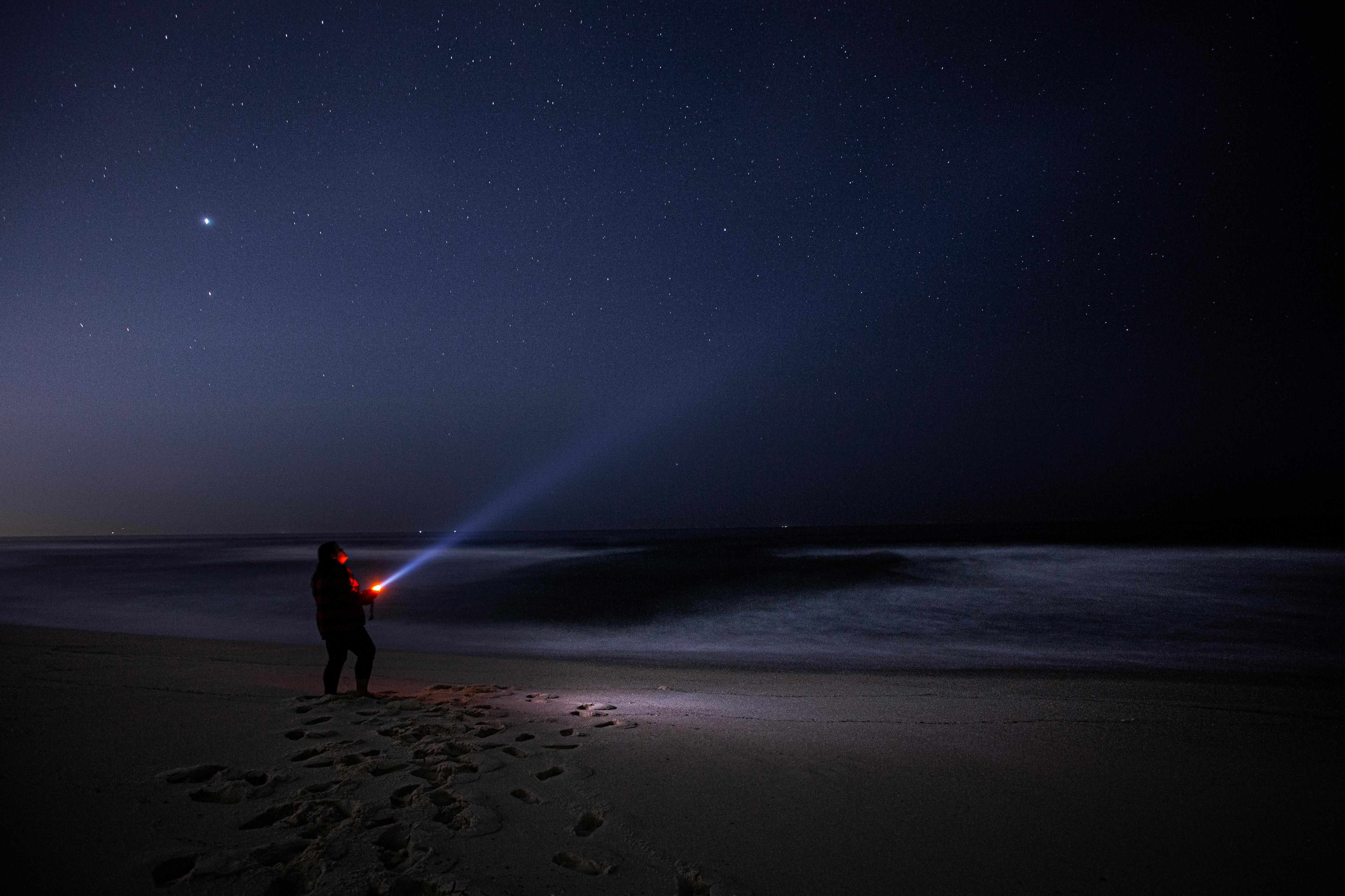 Silhouette of man with blue beam in evening · Free Stock Photo