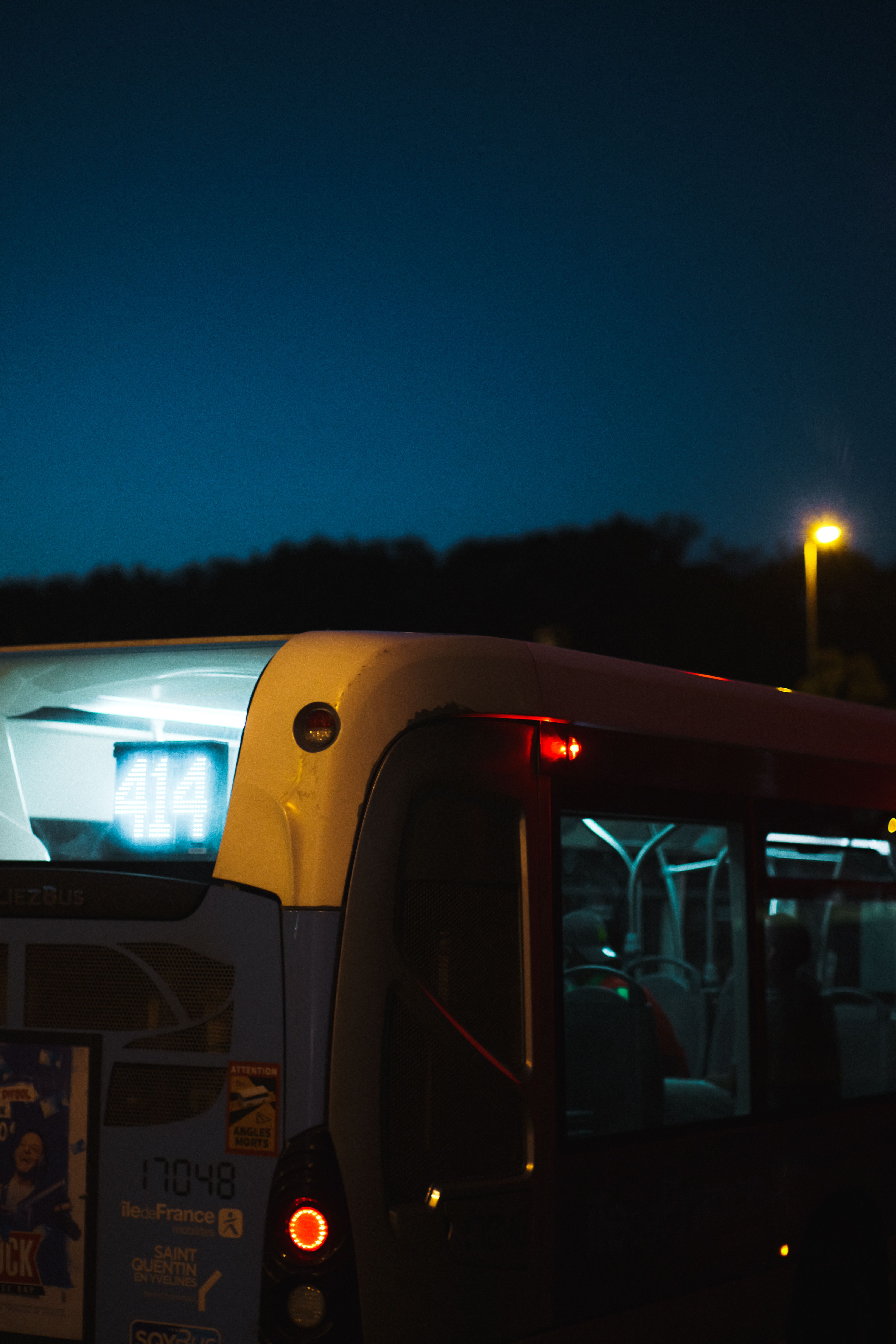 Bus driving on road at night · Free Stock Photo