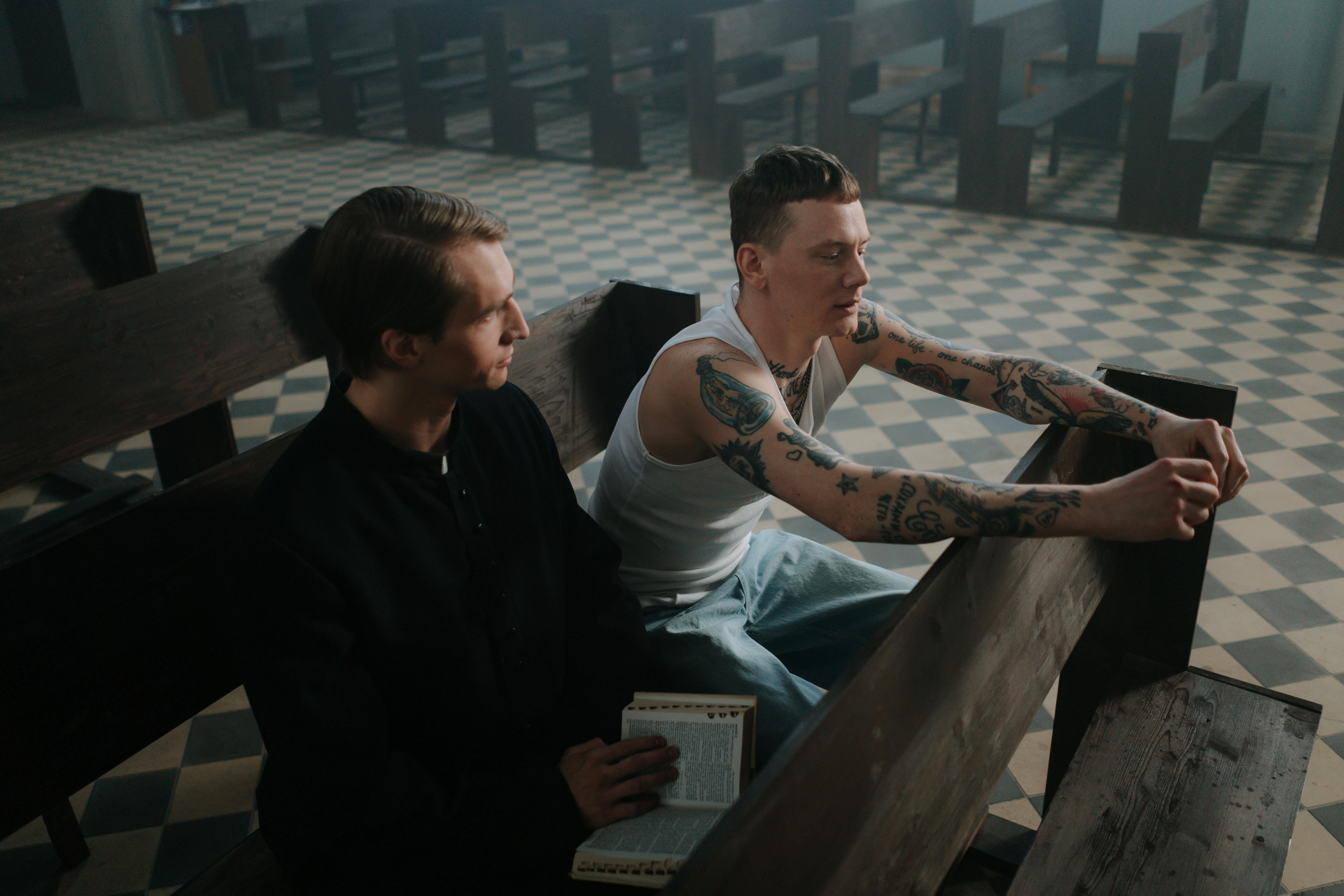 Tattooed Man in White Tank Top Having Conversation with a Priest · Free ...