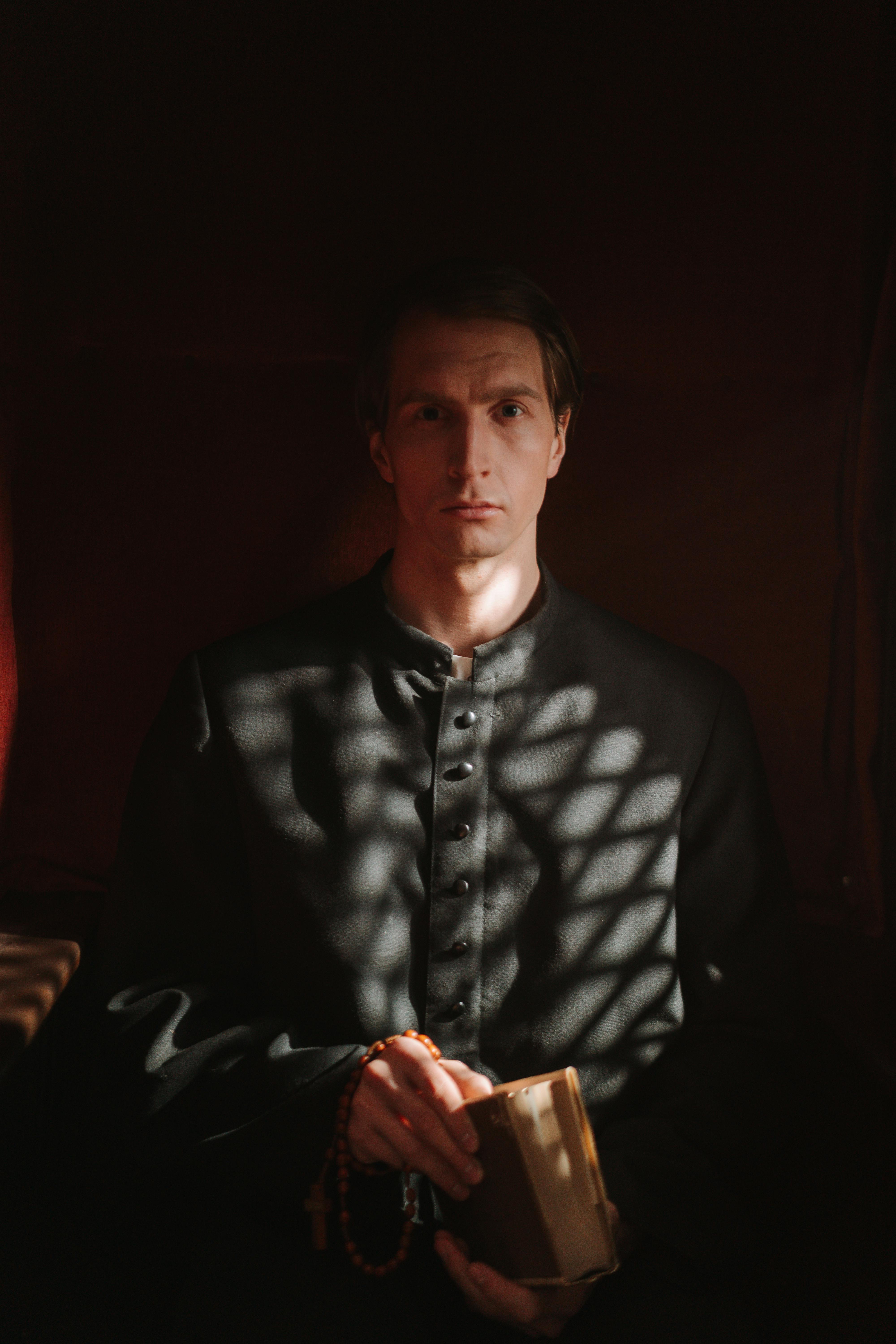 A Priest in Cassock Standing while Looking Up · Free Stock Photo