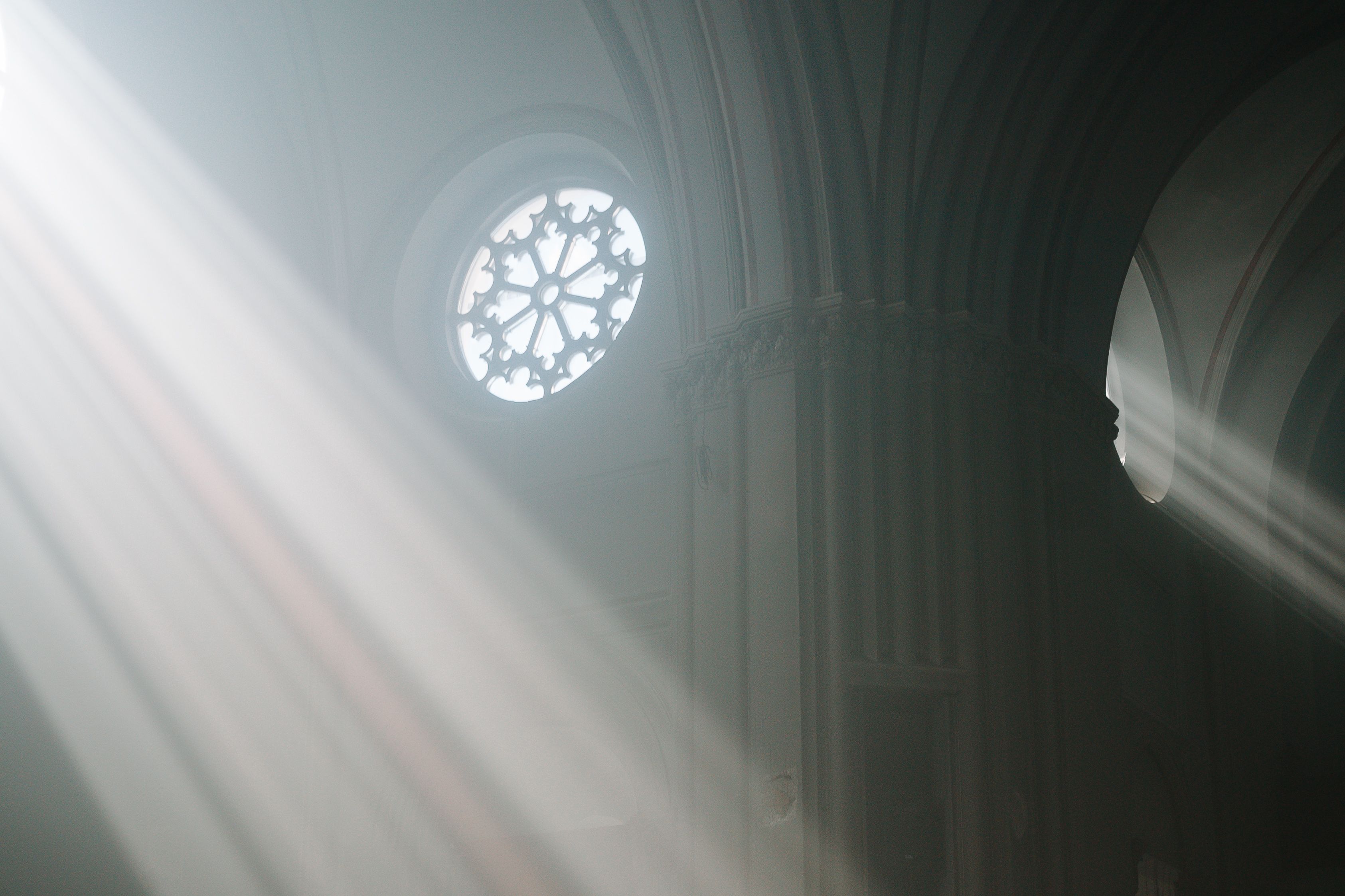 Woman Standing in a Dark Room with a Beam of Light Shining on her Face ...