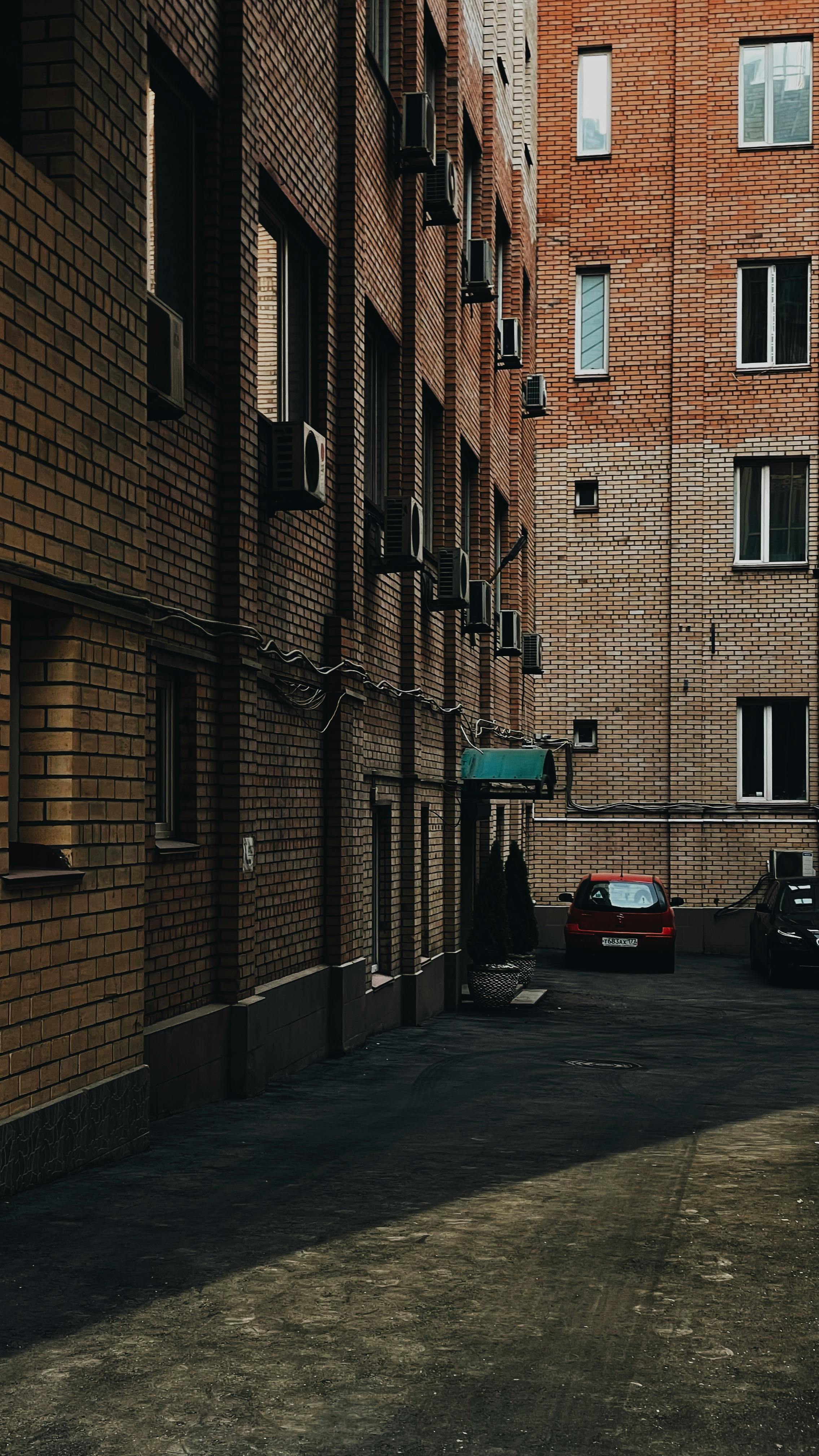 Photo of an Empty Alley Between Buildings · Free Stock Photo