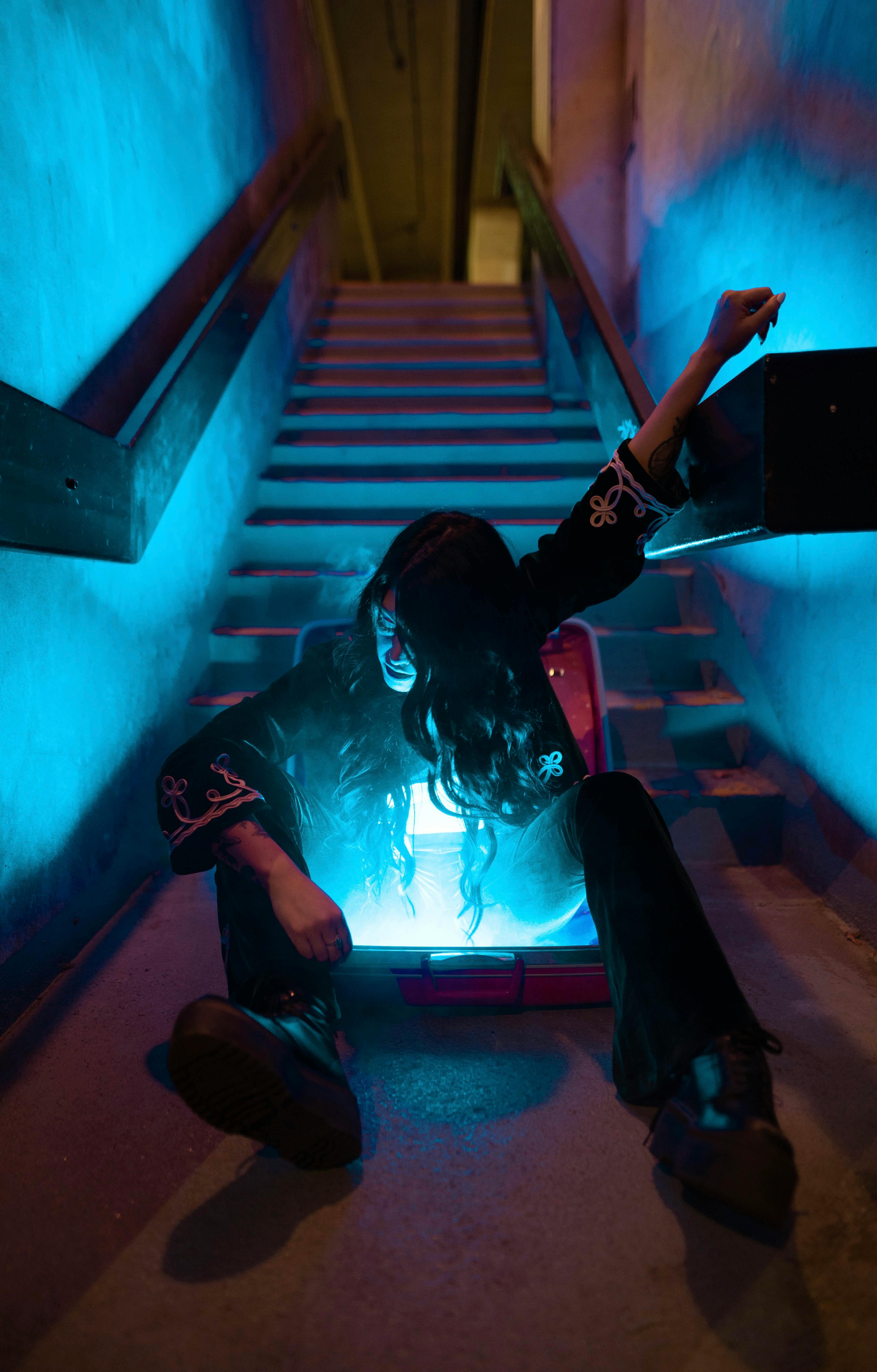 Person Sitting On A Lightning Suitcase · Free Stock Photo