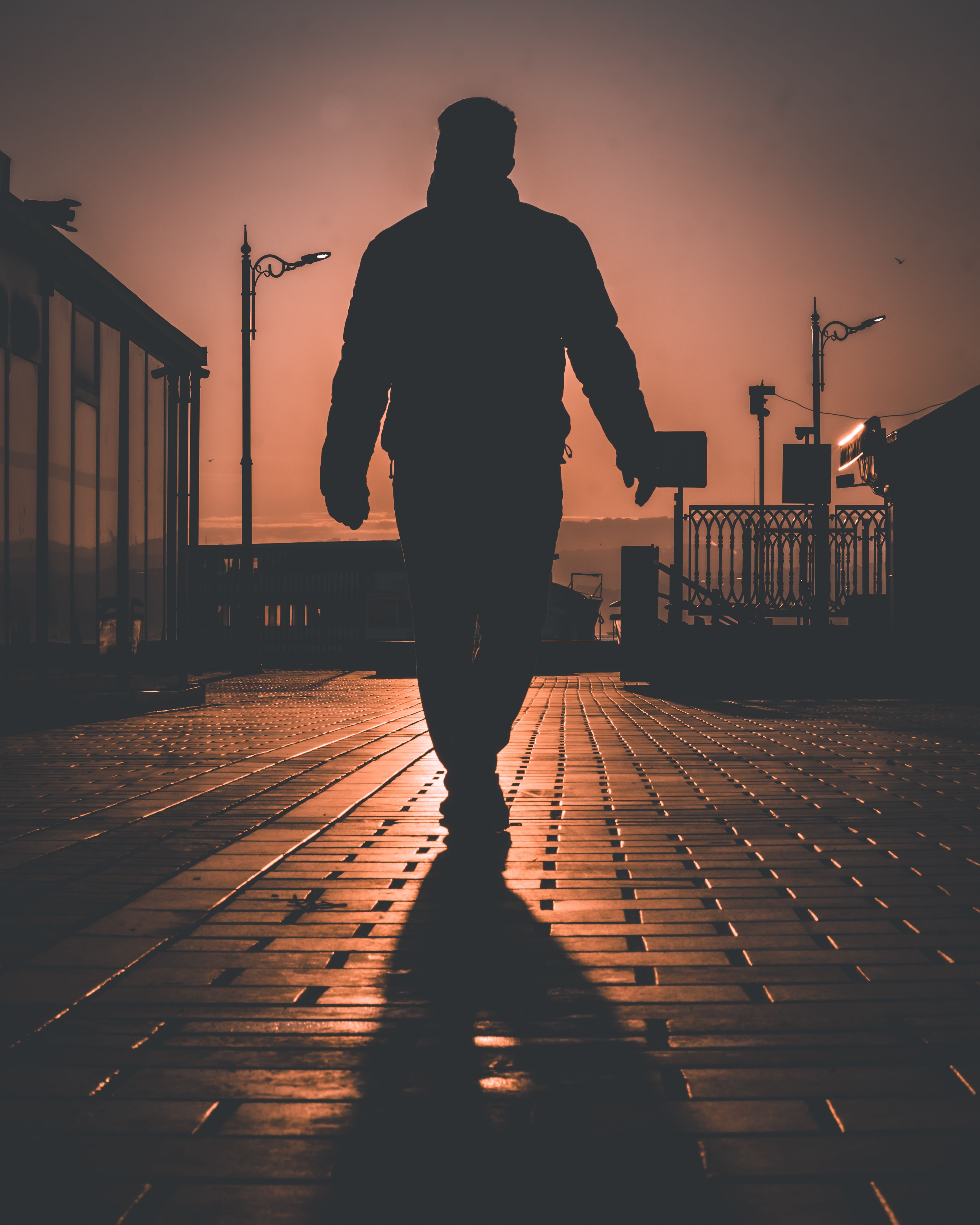 Photo of Man Walking on Pavement · Free Stock Photo