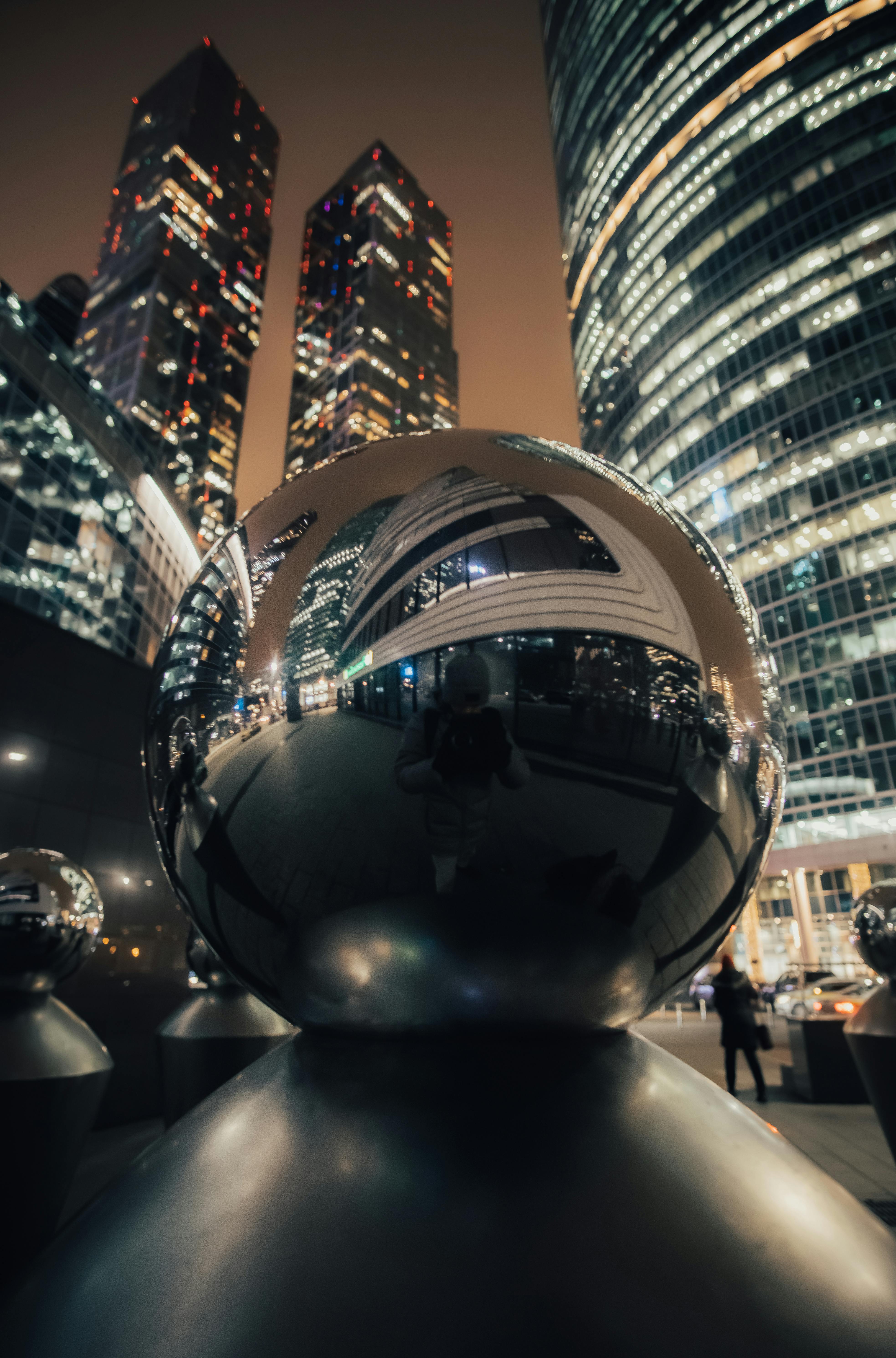 Silver Round Ball Near the Buildings · Free Stock Photo