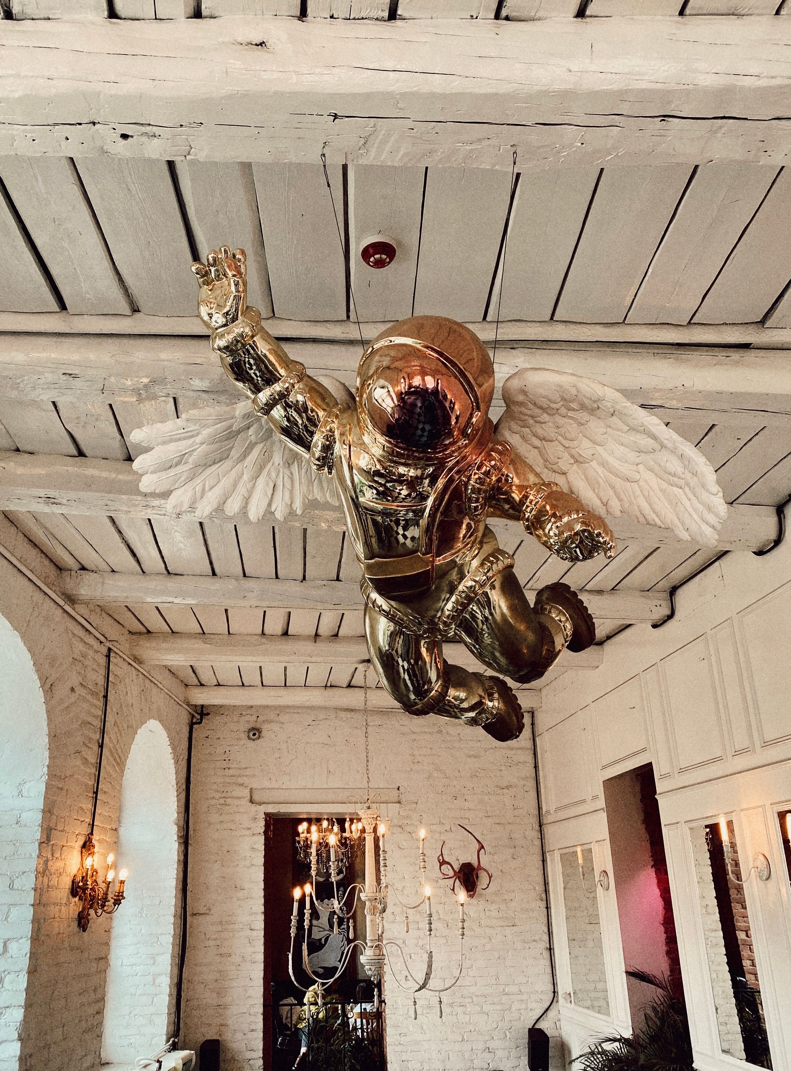 Golden Statue Hanging From the Ceiling · Free Stock Photo