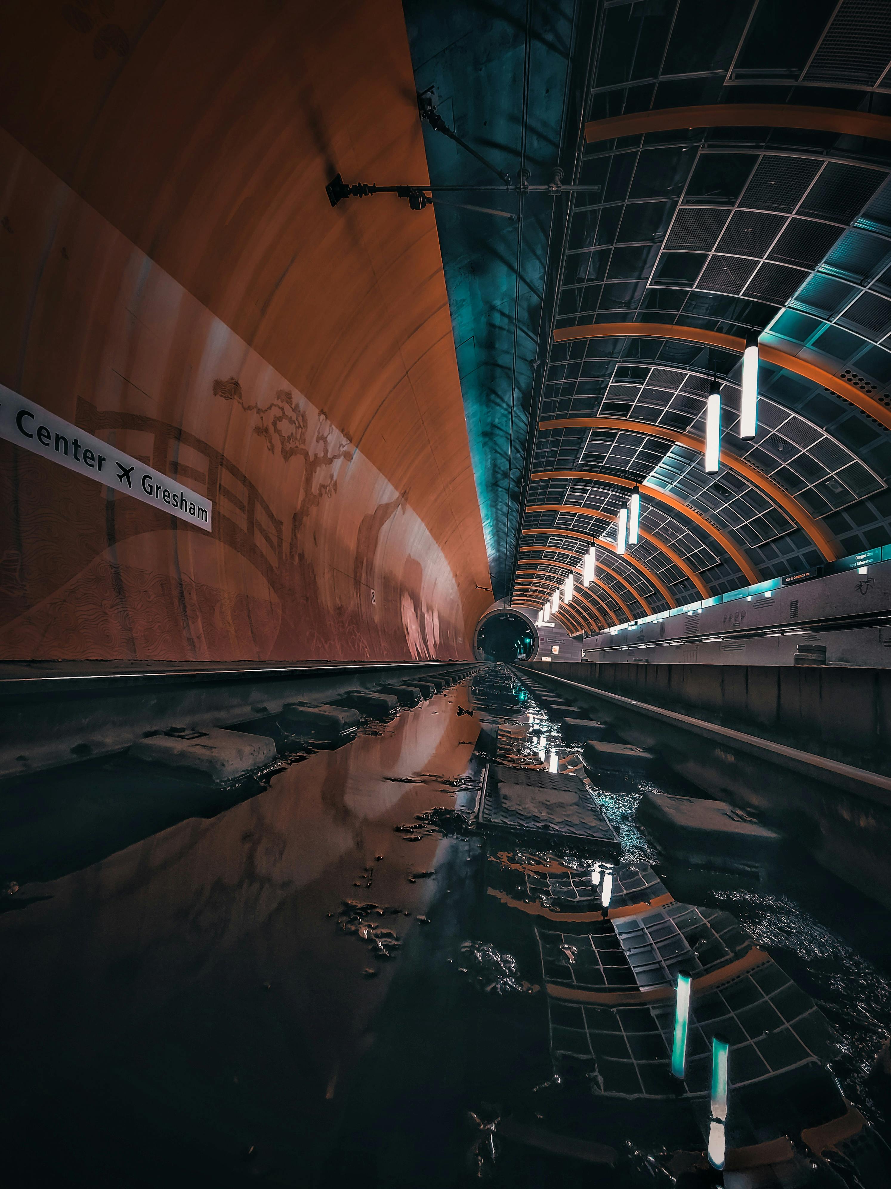 A Railroad Track in a Tunnel with Water · Free Stock Photo