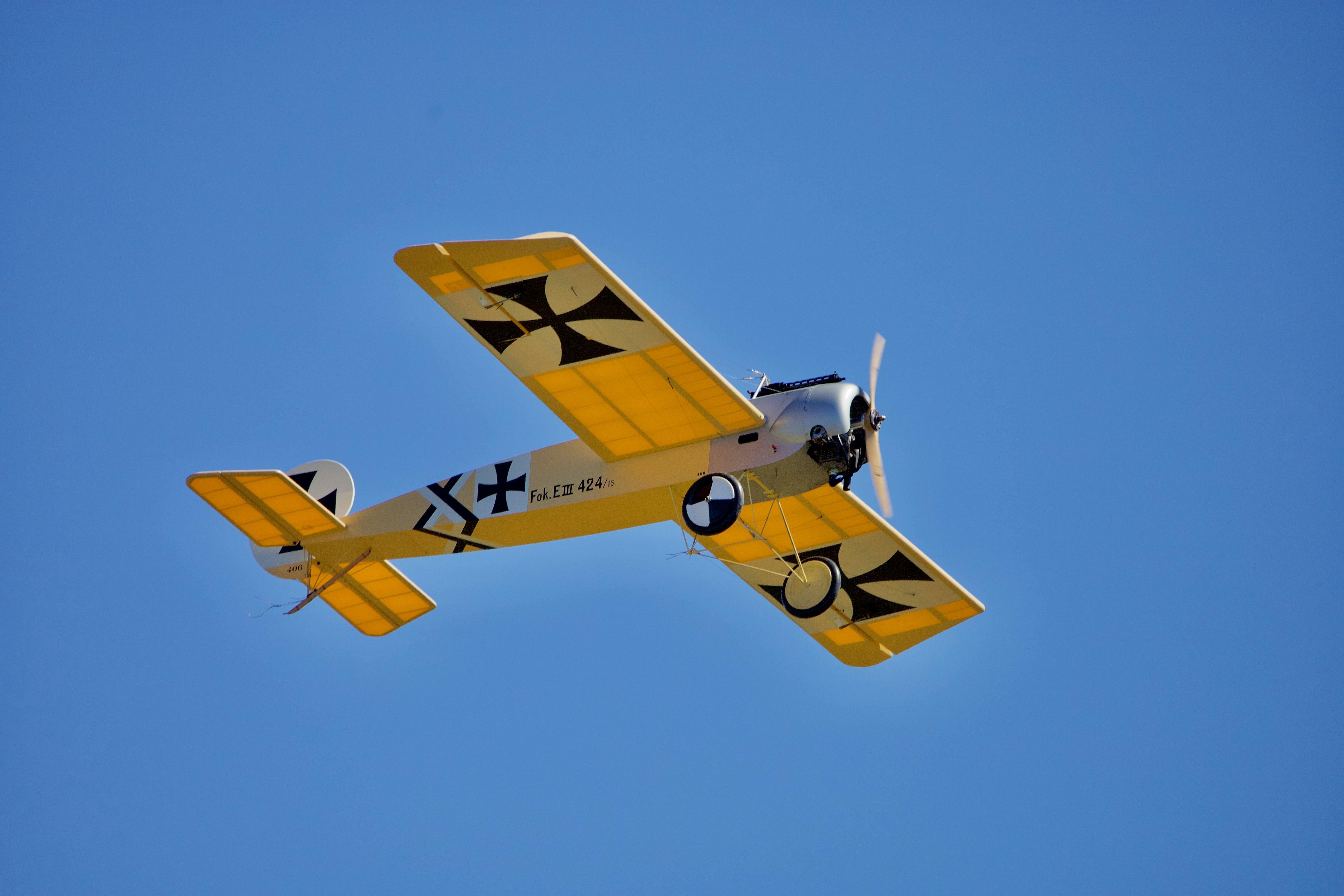 Low-Angle Shot of a Flying Yellow Airplane · Free Stock Photo