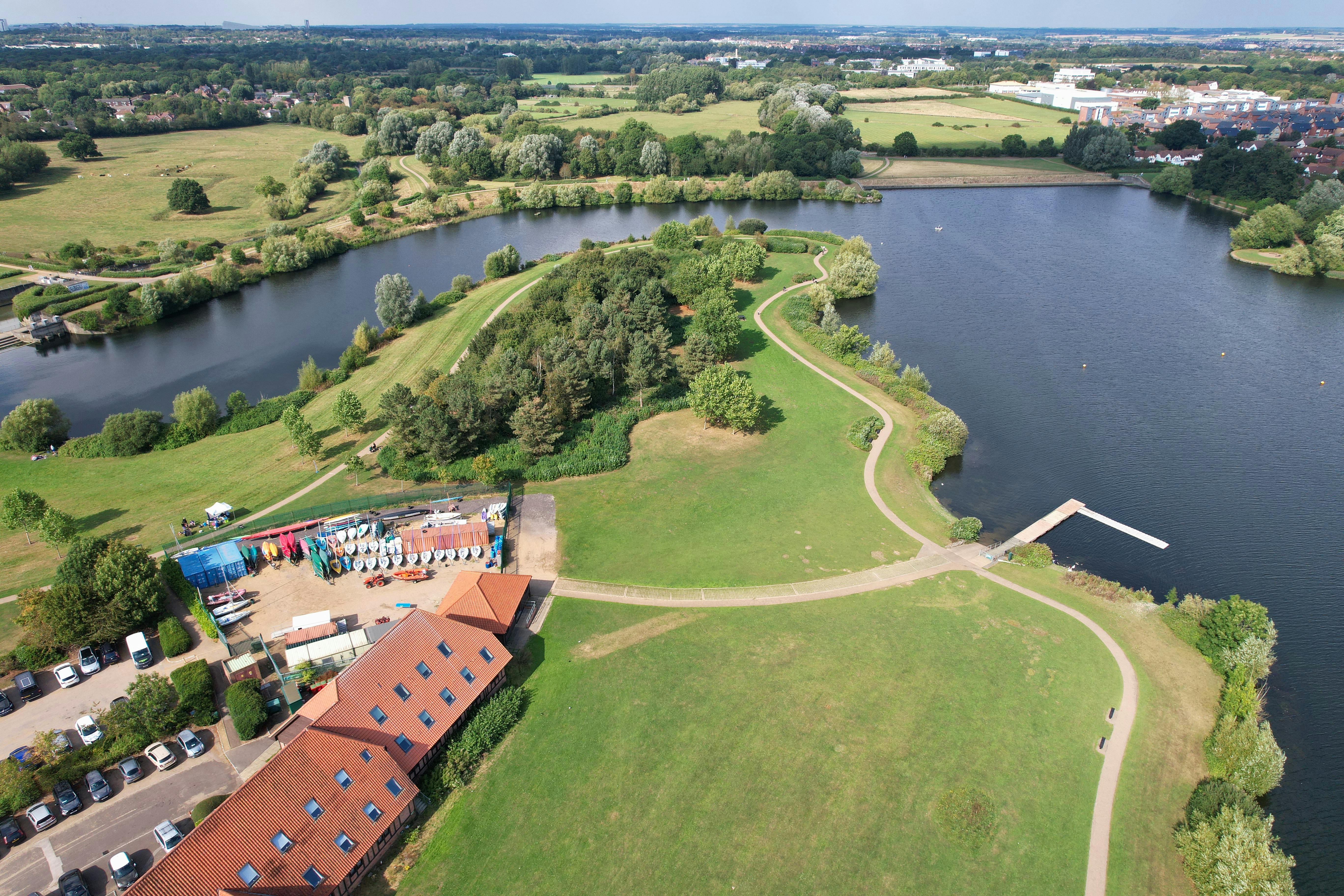 An Aerial Photography of Green Grass Field Near Body of Water · Free ...