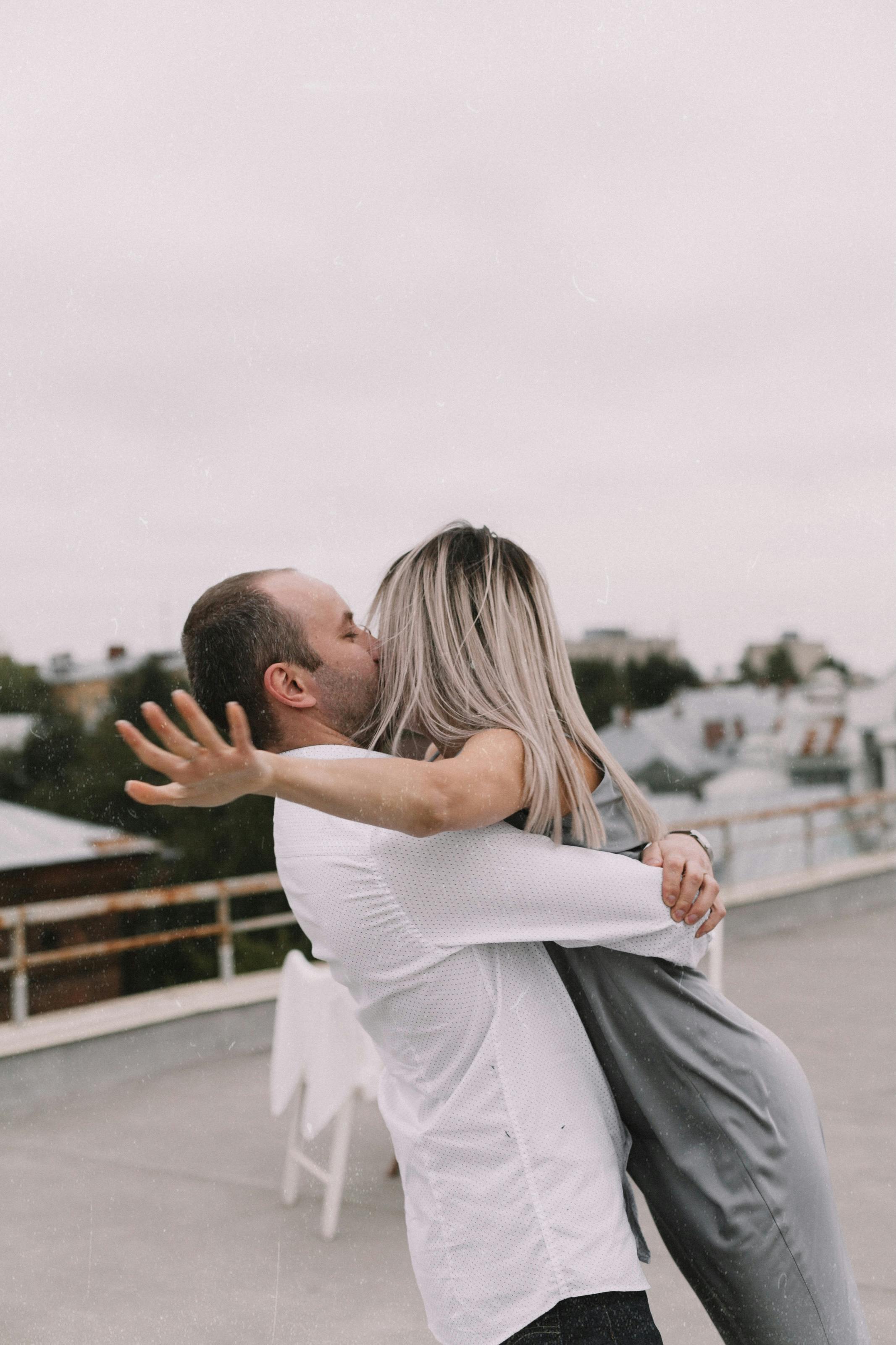 A Man Carrying His Partner while Kissing · Free Stock Photo