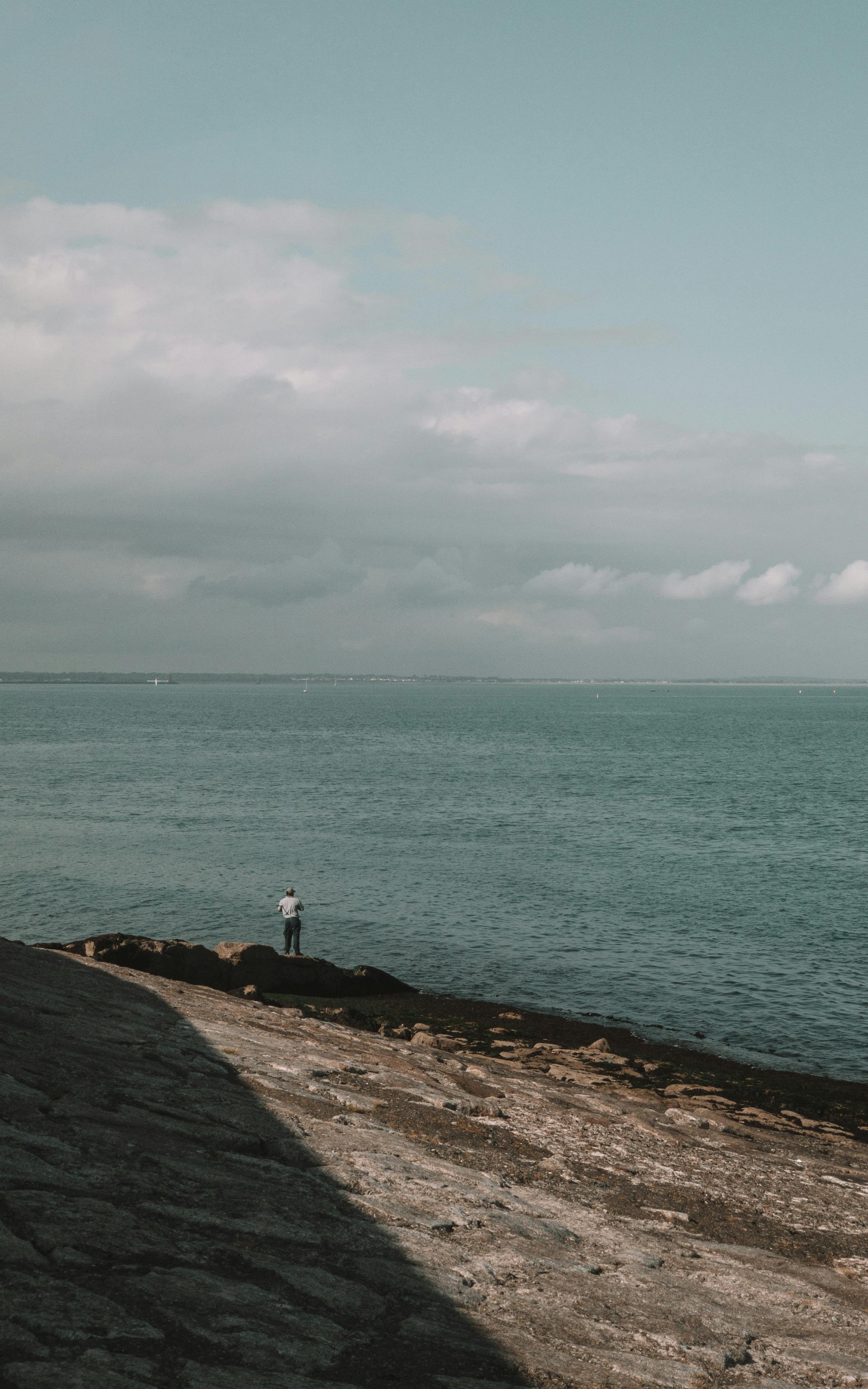A Man Standing near the Sea · Free Stock Photo