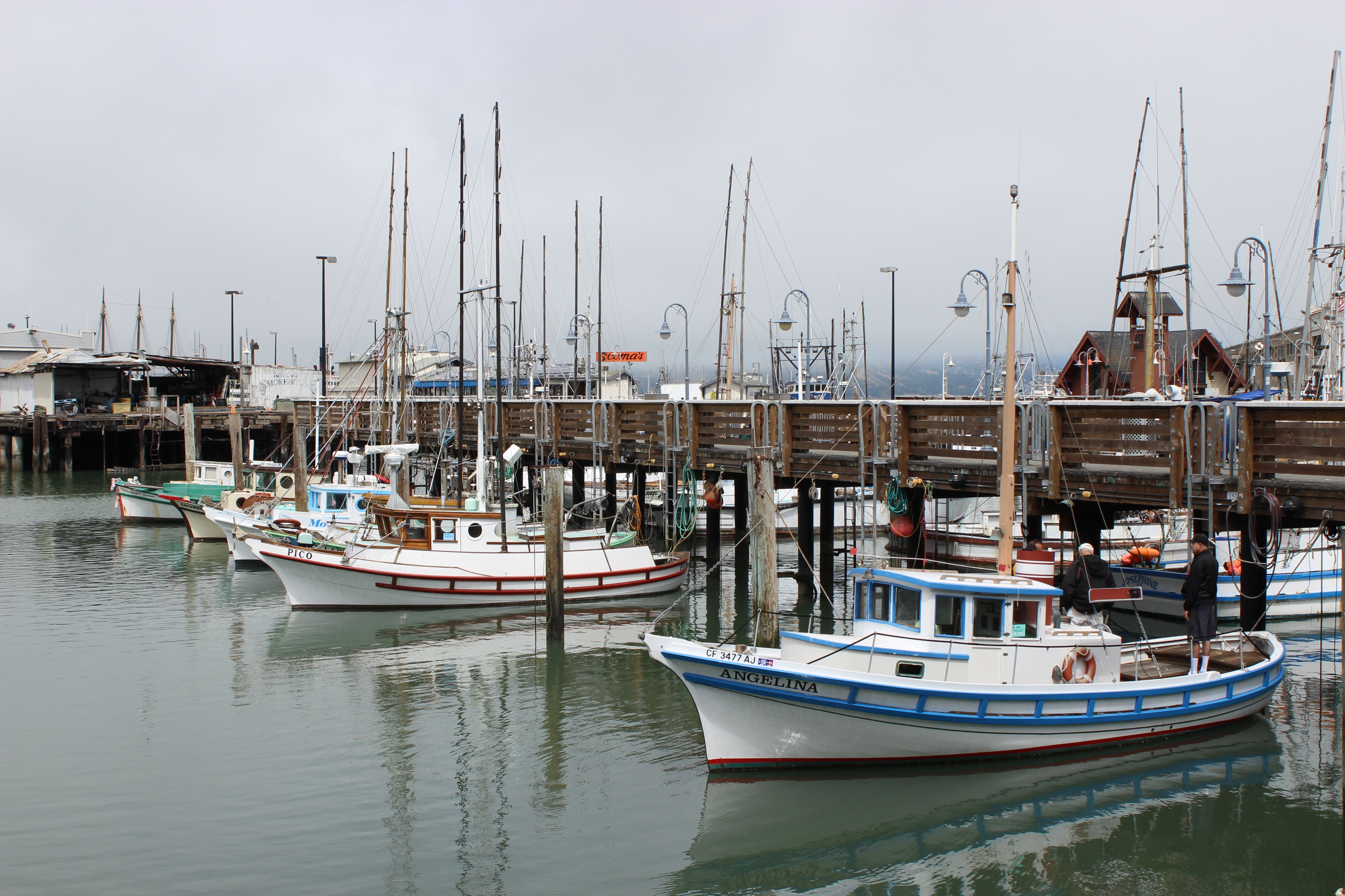 A Boat on Dock near Cars · Free Stock Photo