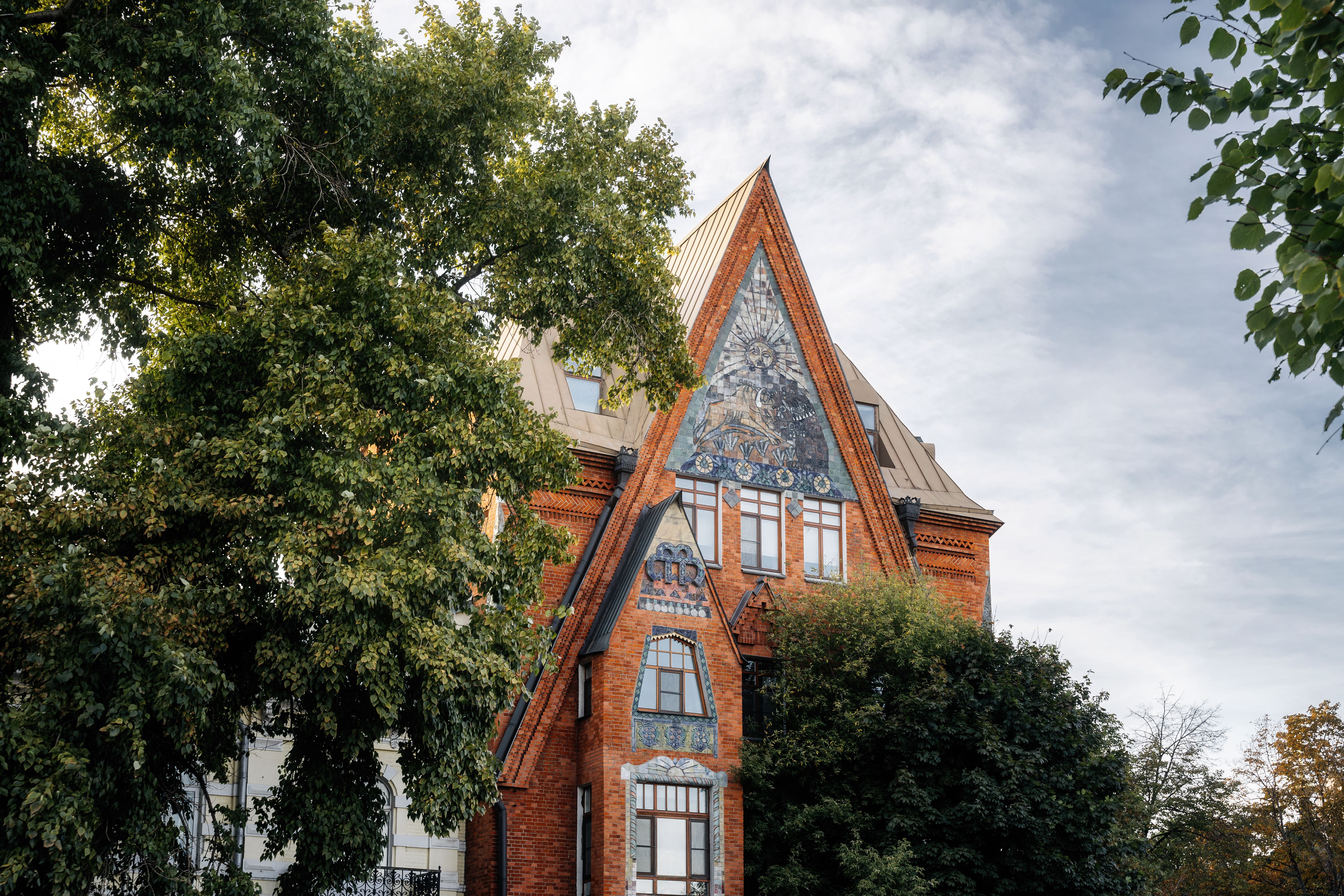 Decorative Brick Building with Mosaics and Trees · Free Stock Photo