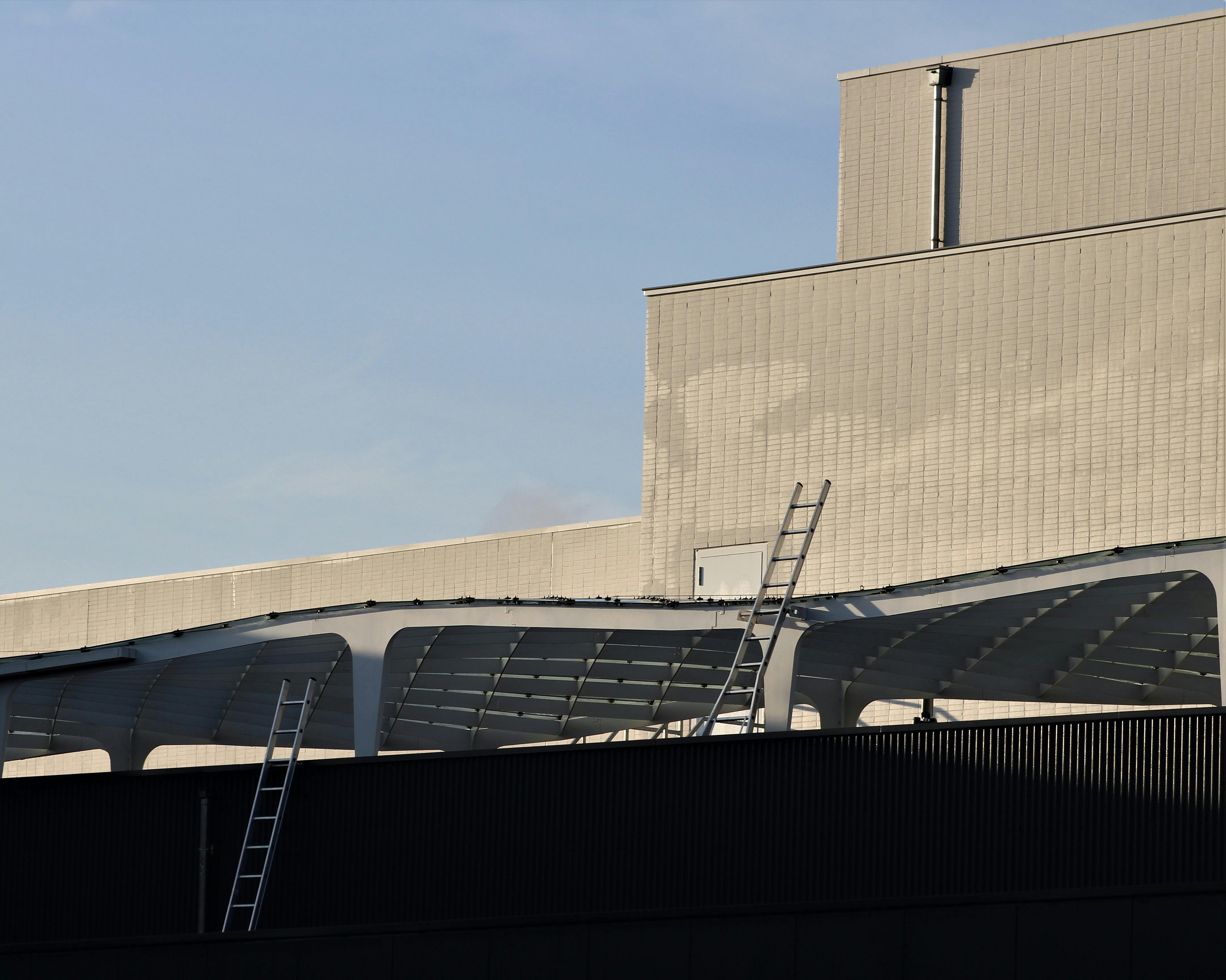 Photo of a Gray Building and Ladders · Free Stock Photo