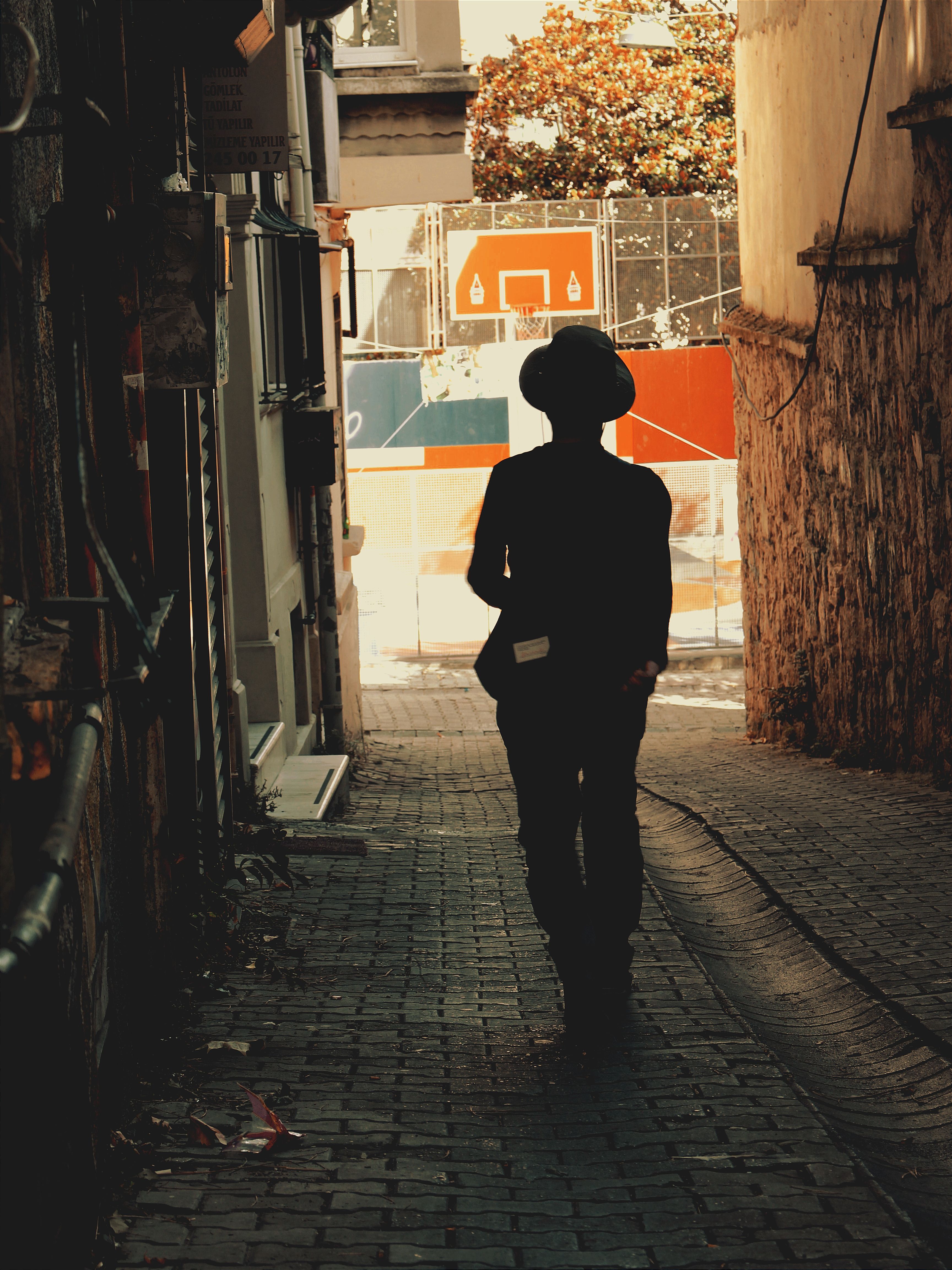 Man Carrying Two Full Buckets Through a City Street · Free Stock Photo