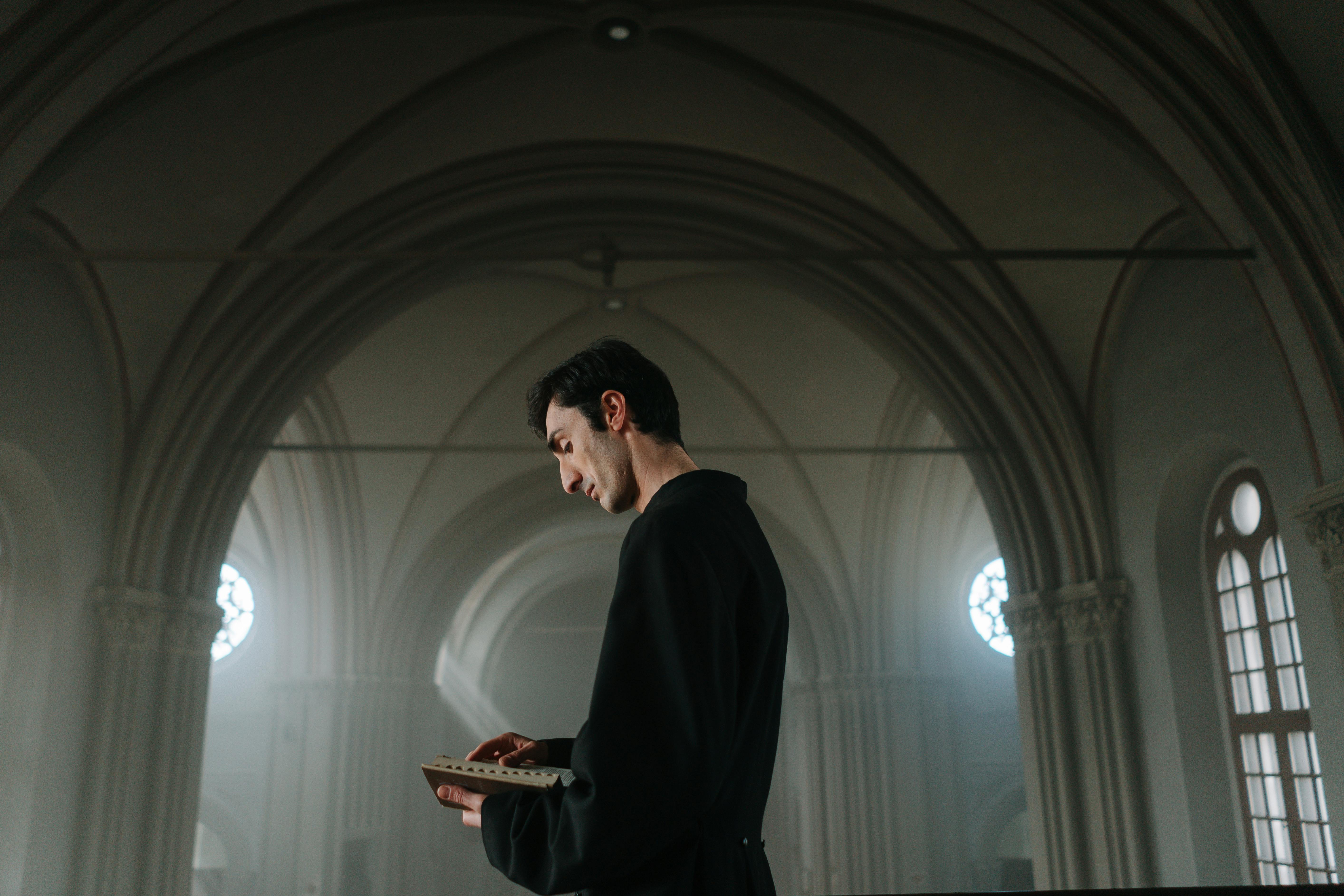 Side View of a Priest Standing in a Church · Free Stock Photo