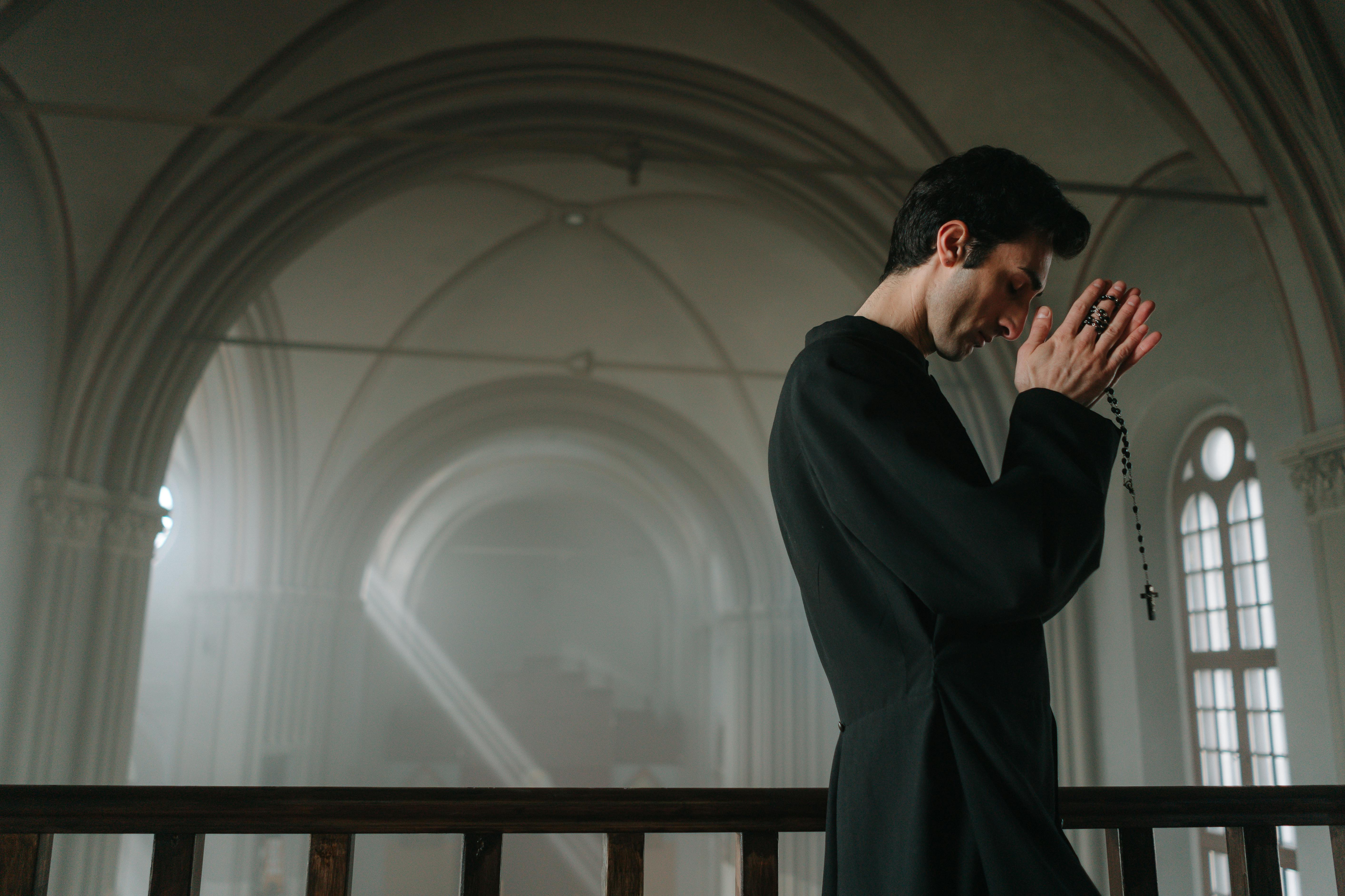 Man in Black Suit Standing Near Black Railing · Free Stock Photo