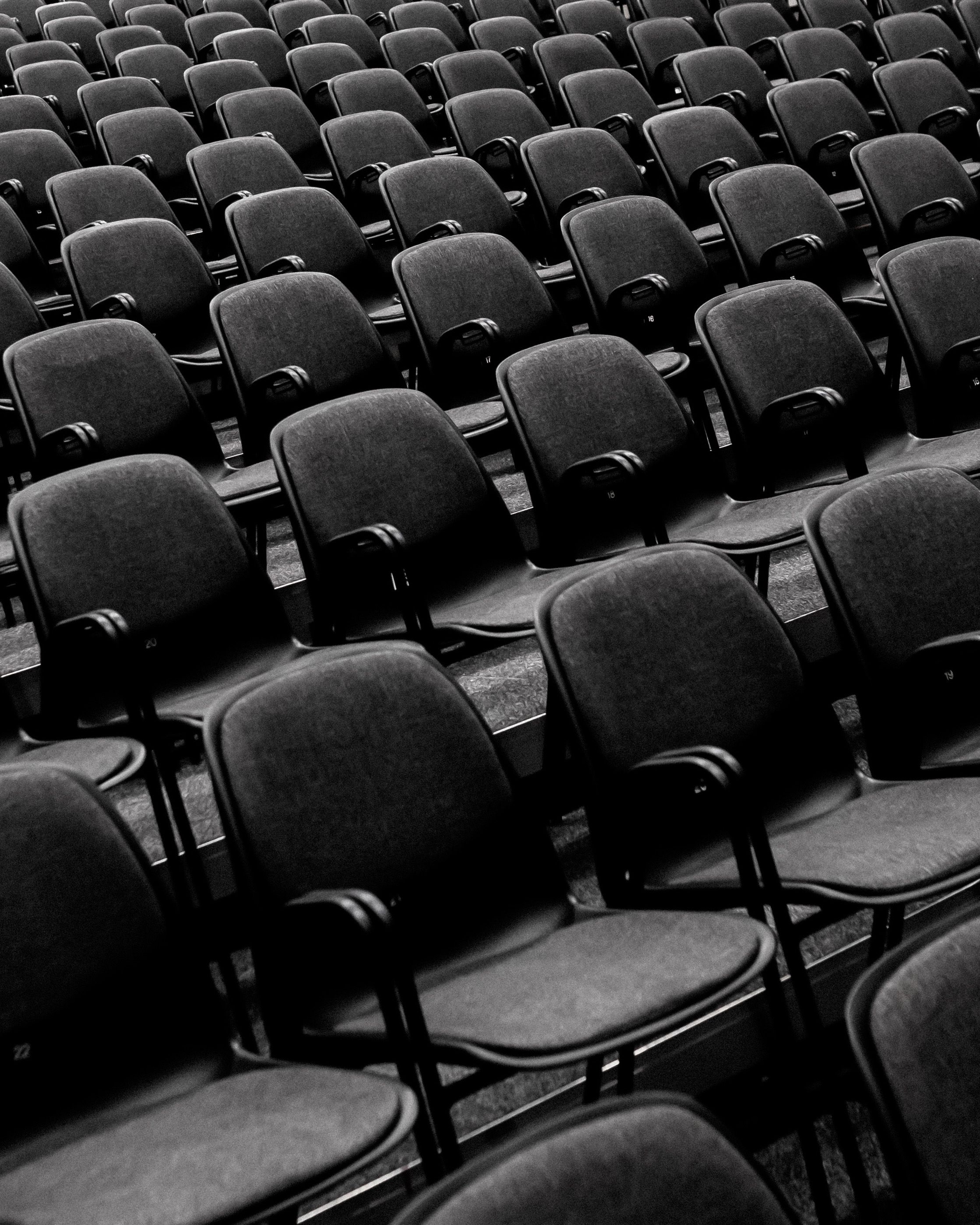 Grayscale Photo of Empty Seats · Free Stock Photo